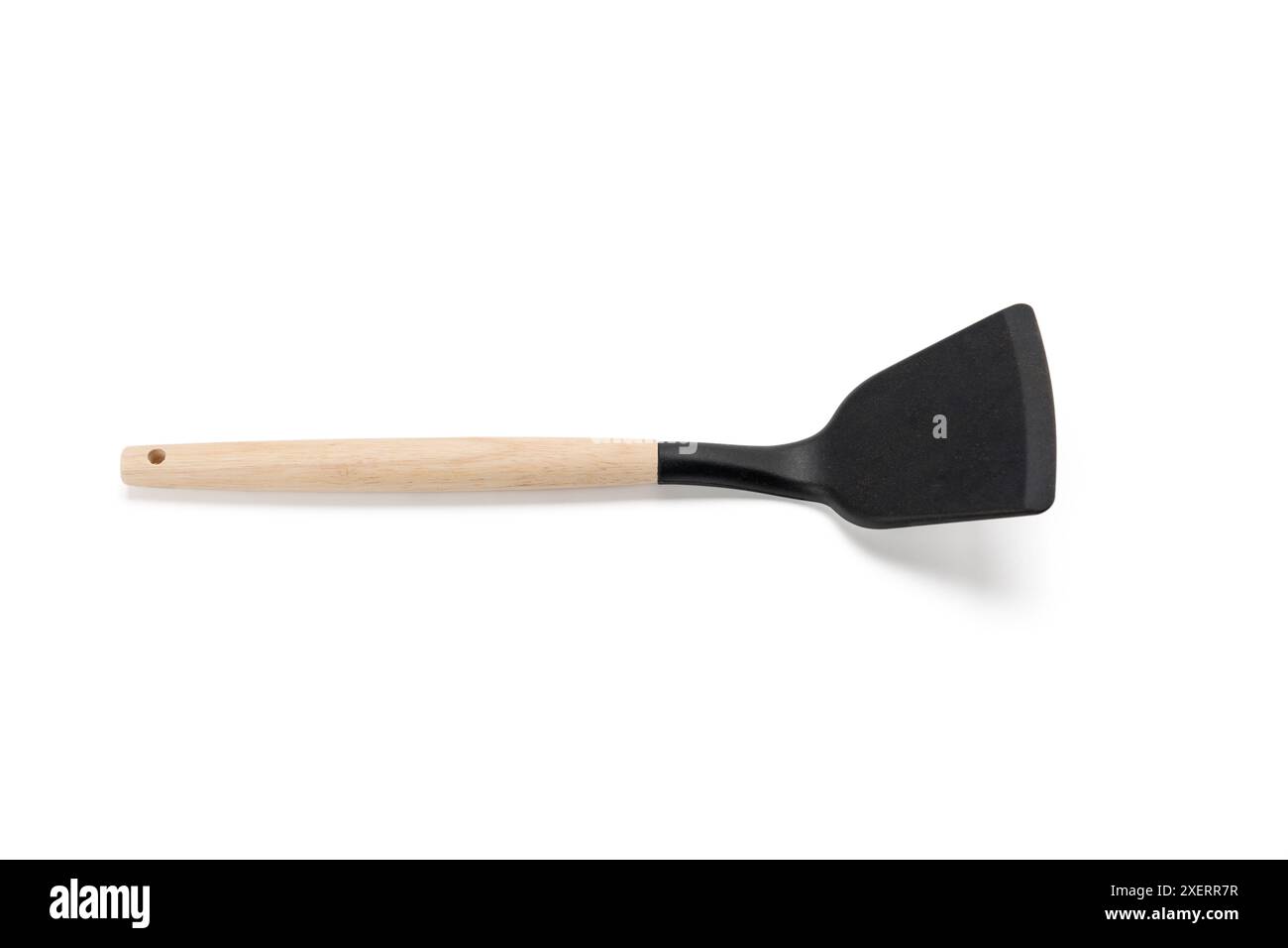 Black spatula with wooden handle. The spatula is long and thin. It is ...