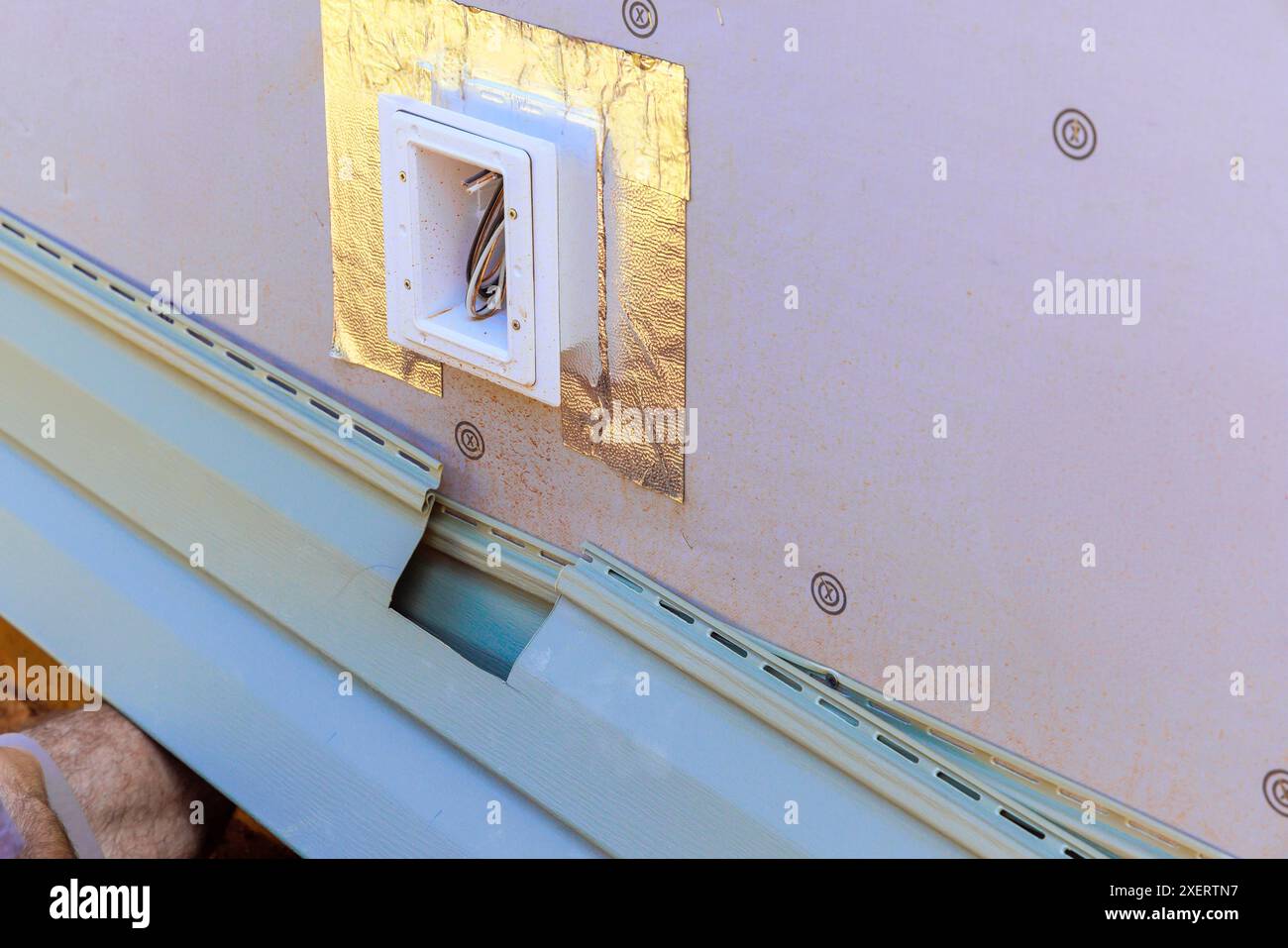 Installation of vinyl plastic siding panels on new home facade Stock ...