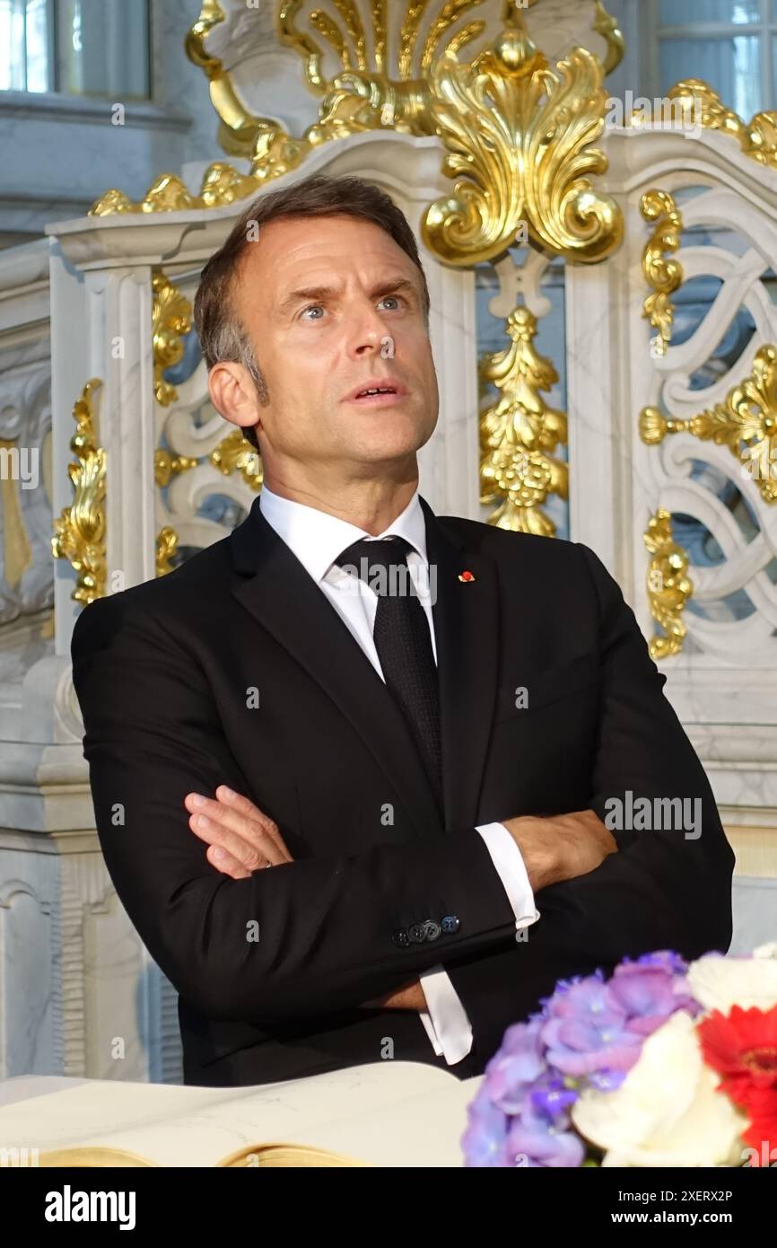 French president Emmanuel Macron with arms crossed and looking up ...