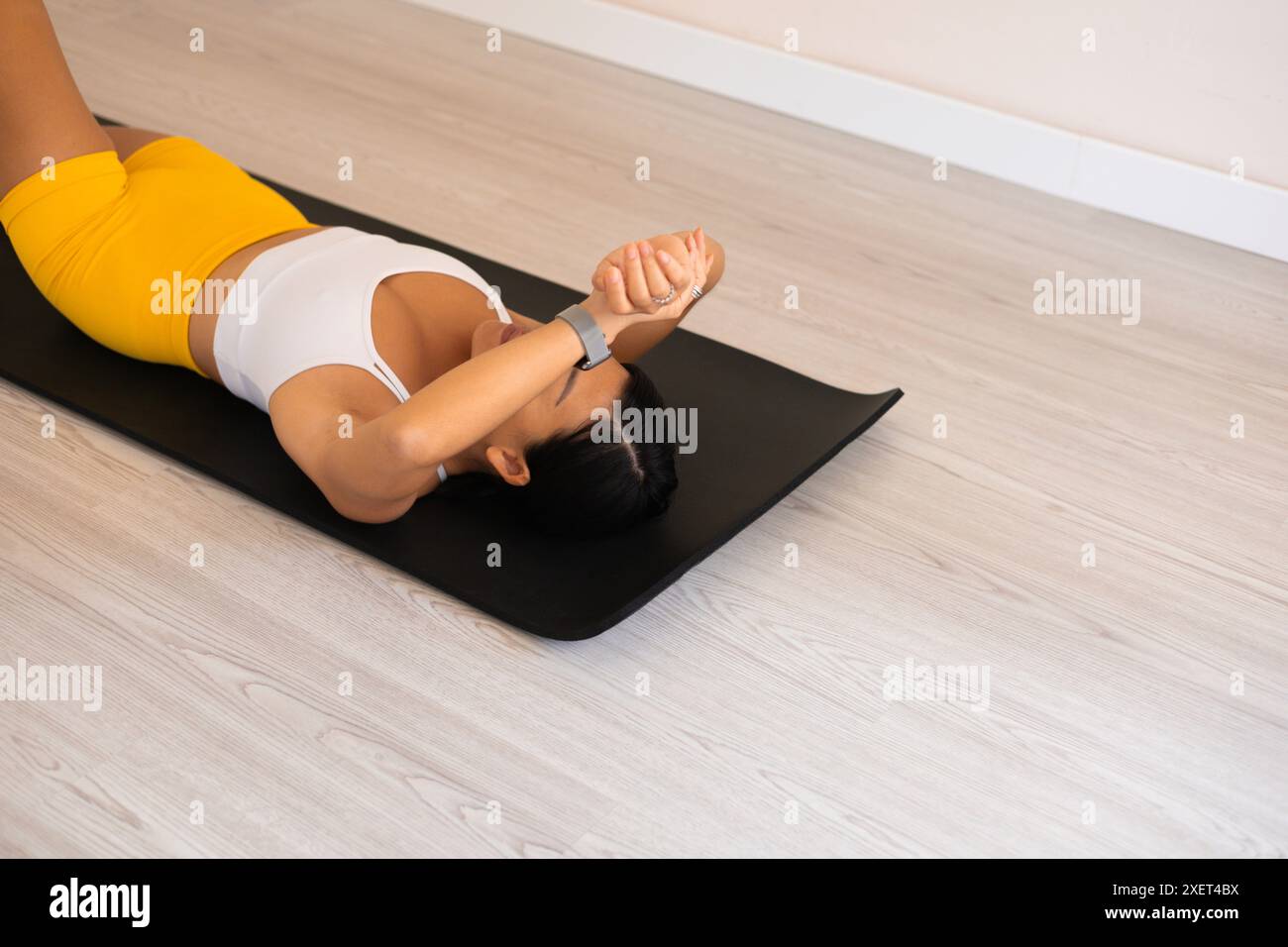 Tired woman laying on a mat after fitness exersises Stock Photo - Alamy
