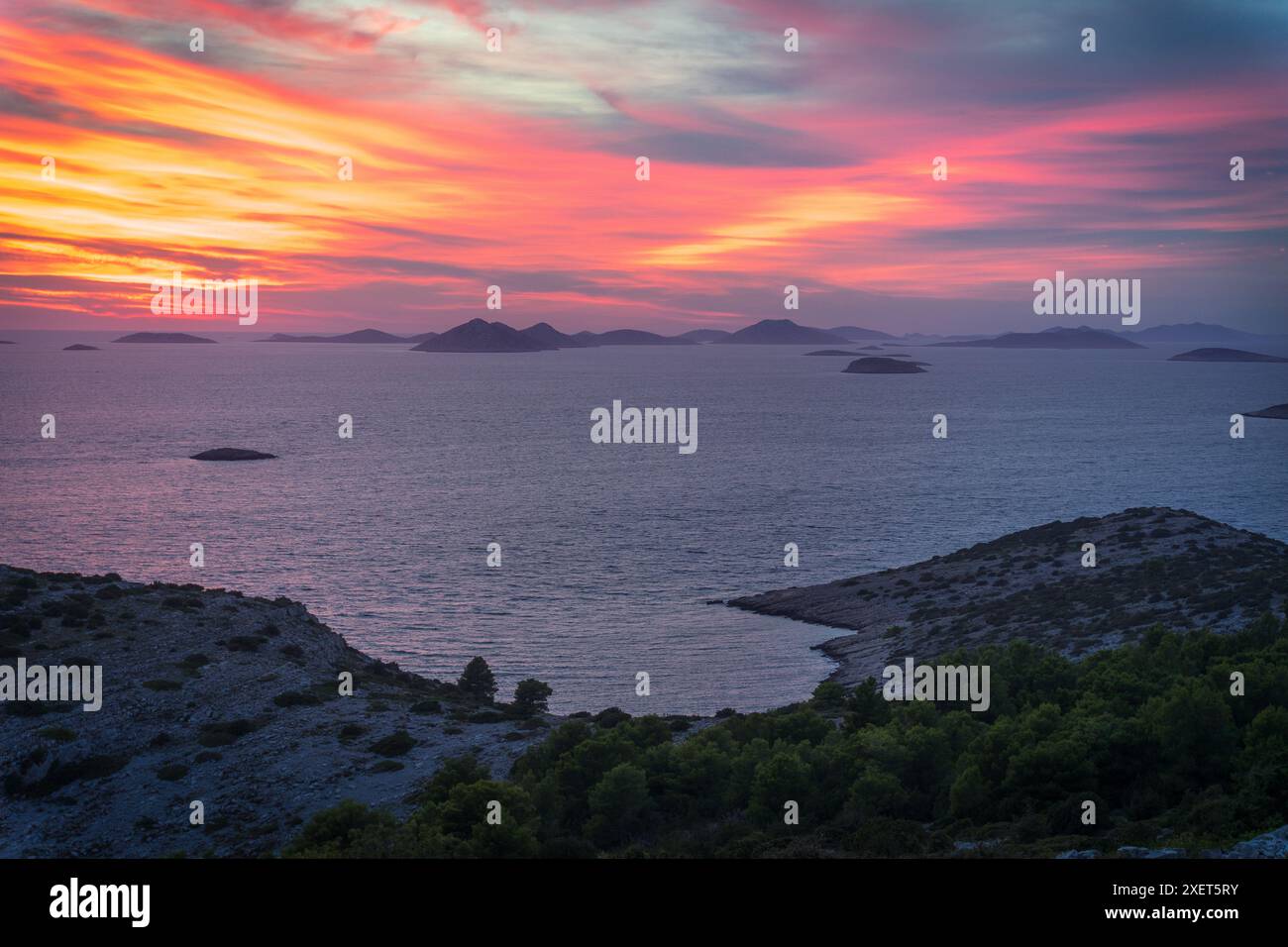 Colorful sky and picturesque islands of Adriatic sea, shot from Žirje ...