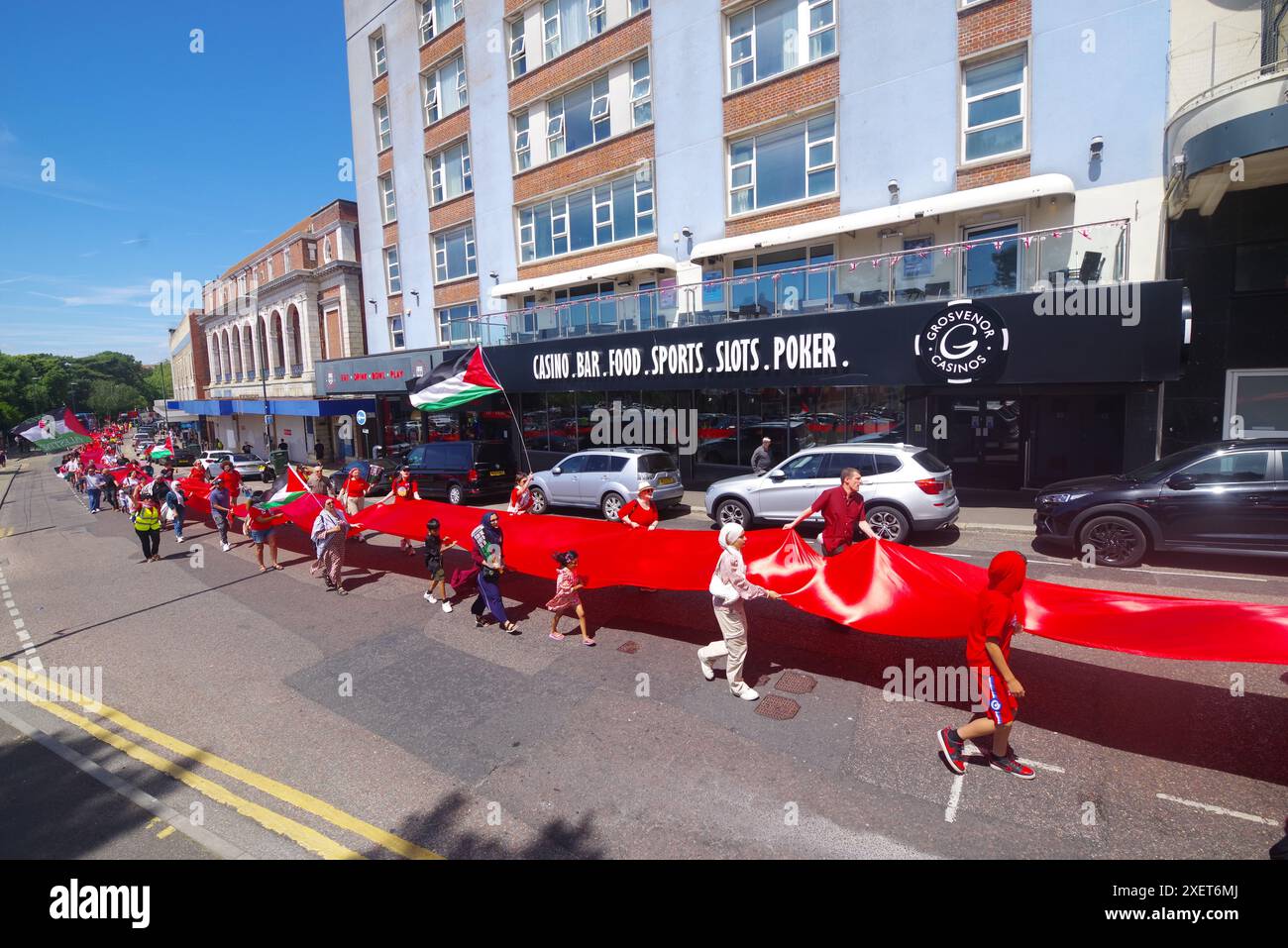 Over 500 people held and carried the peoples red line in Bournemouth June 29 2024. Holding a ...