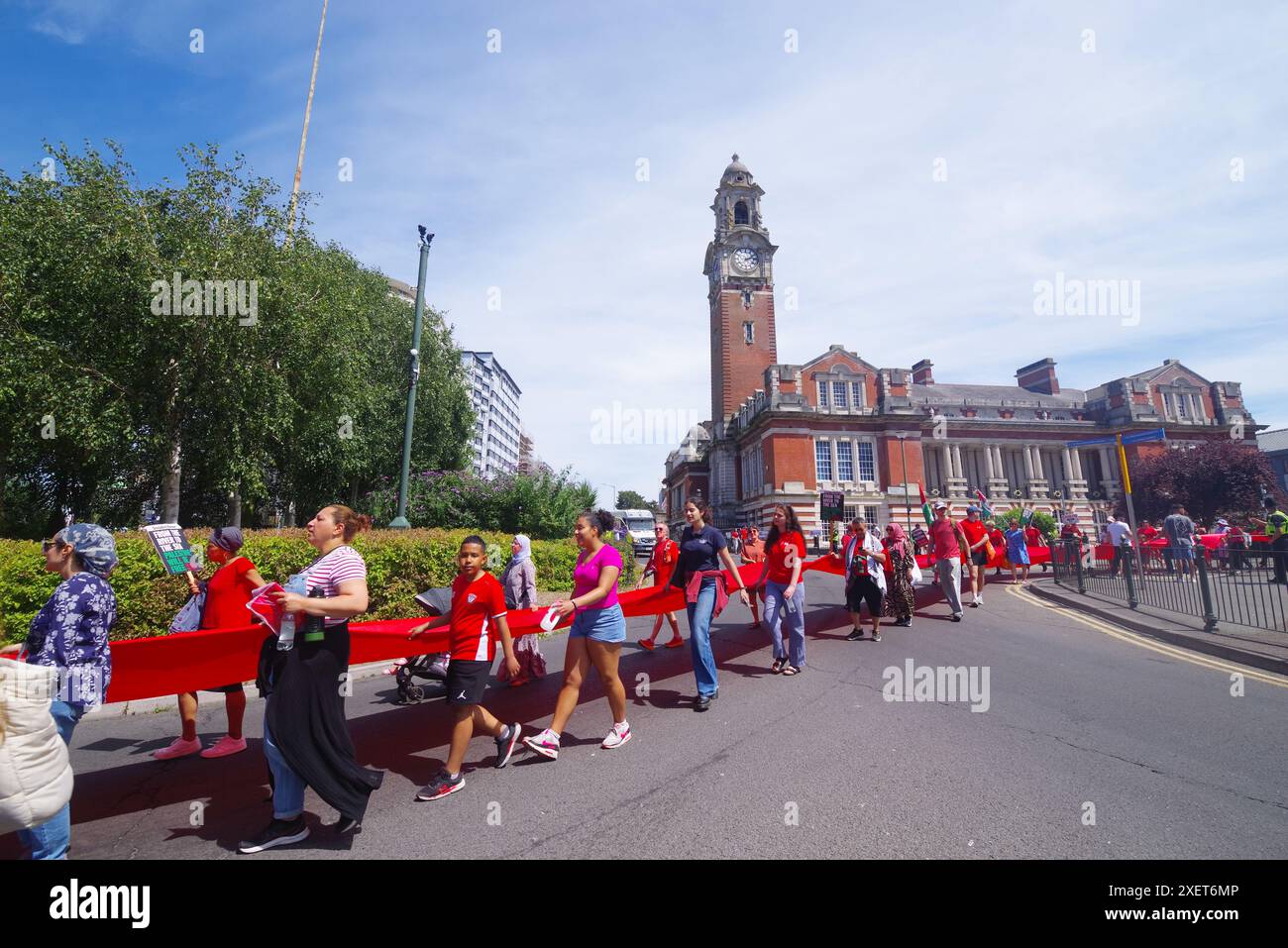 Over 500 people held and carried the peoples red line in Bournemouth June 29 2024. Holding a ...