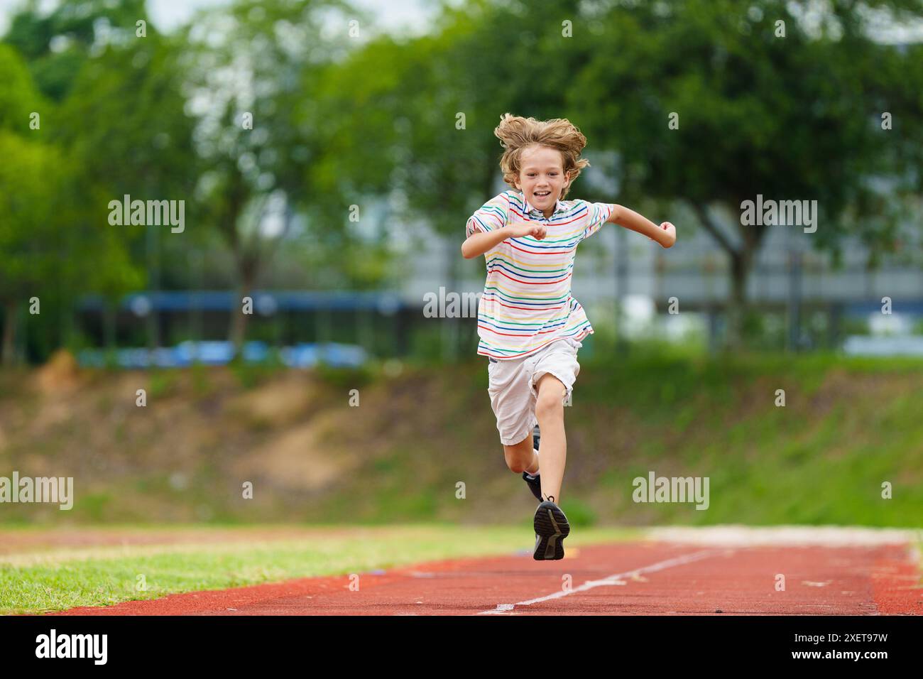 Kids long jump athletics training. Child jumping in sand pit on school ...