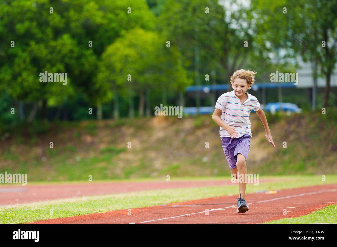 Kids long jump athletics training. Child jumping in sand pit on school ...