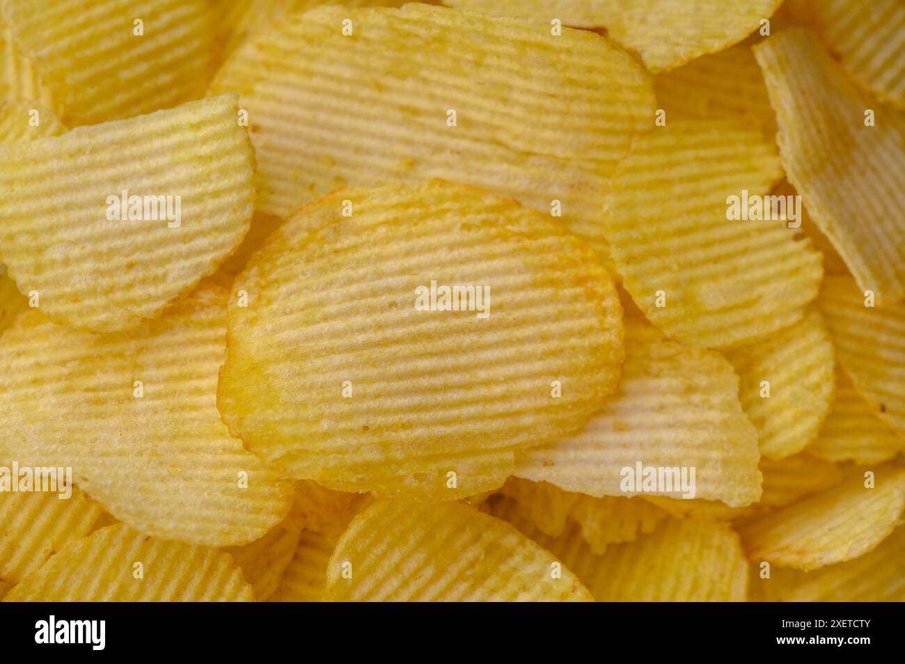 A stack of potato chips, a popular junk food, placed 1 Stock Photo - Alamy