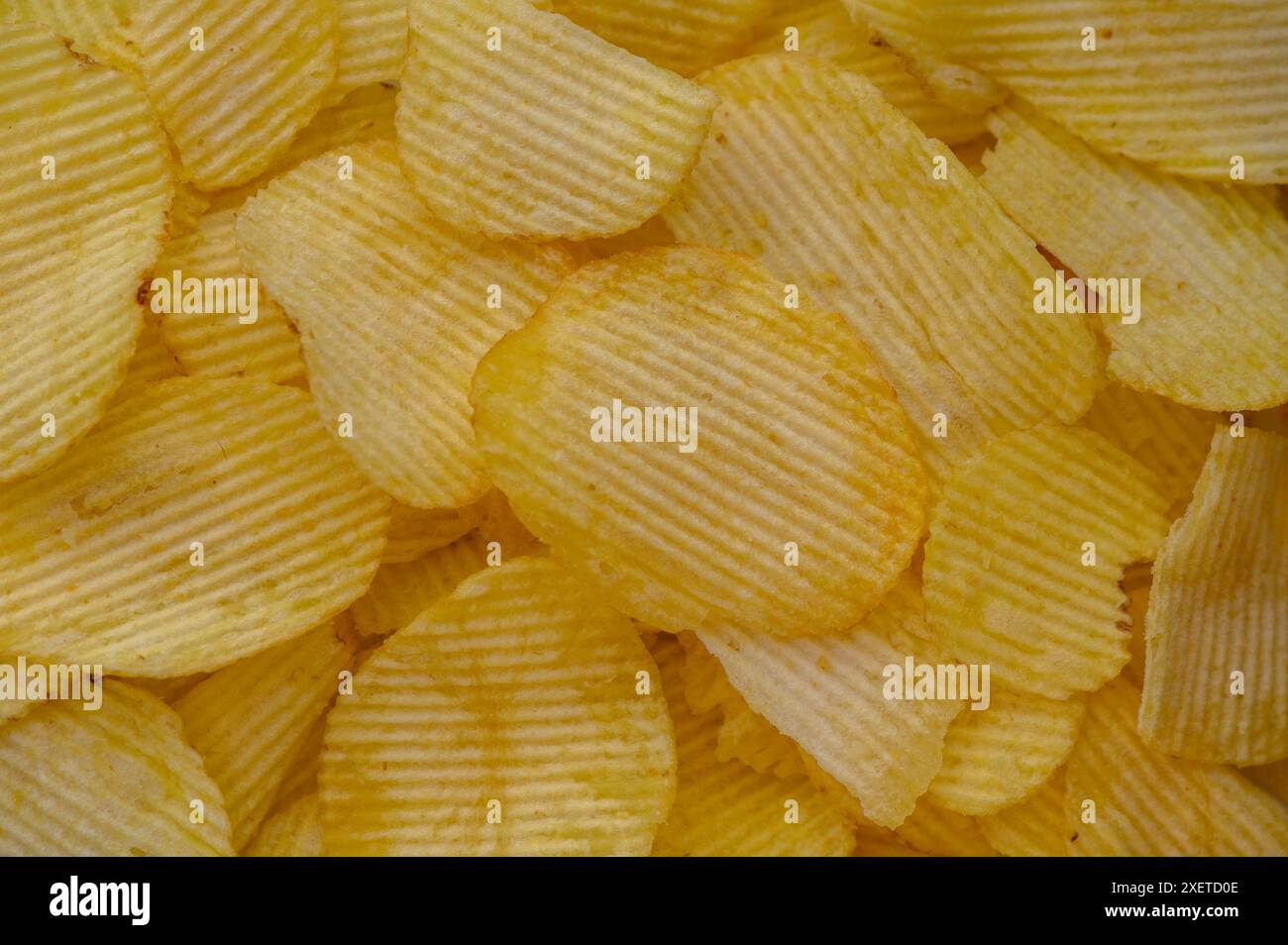 A stack of potato chips, a popular junk food, placed Stock Photo - Alamy