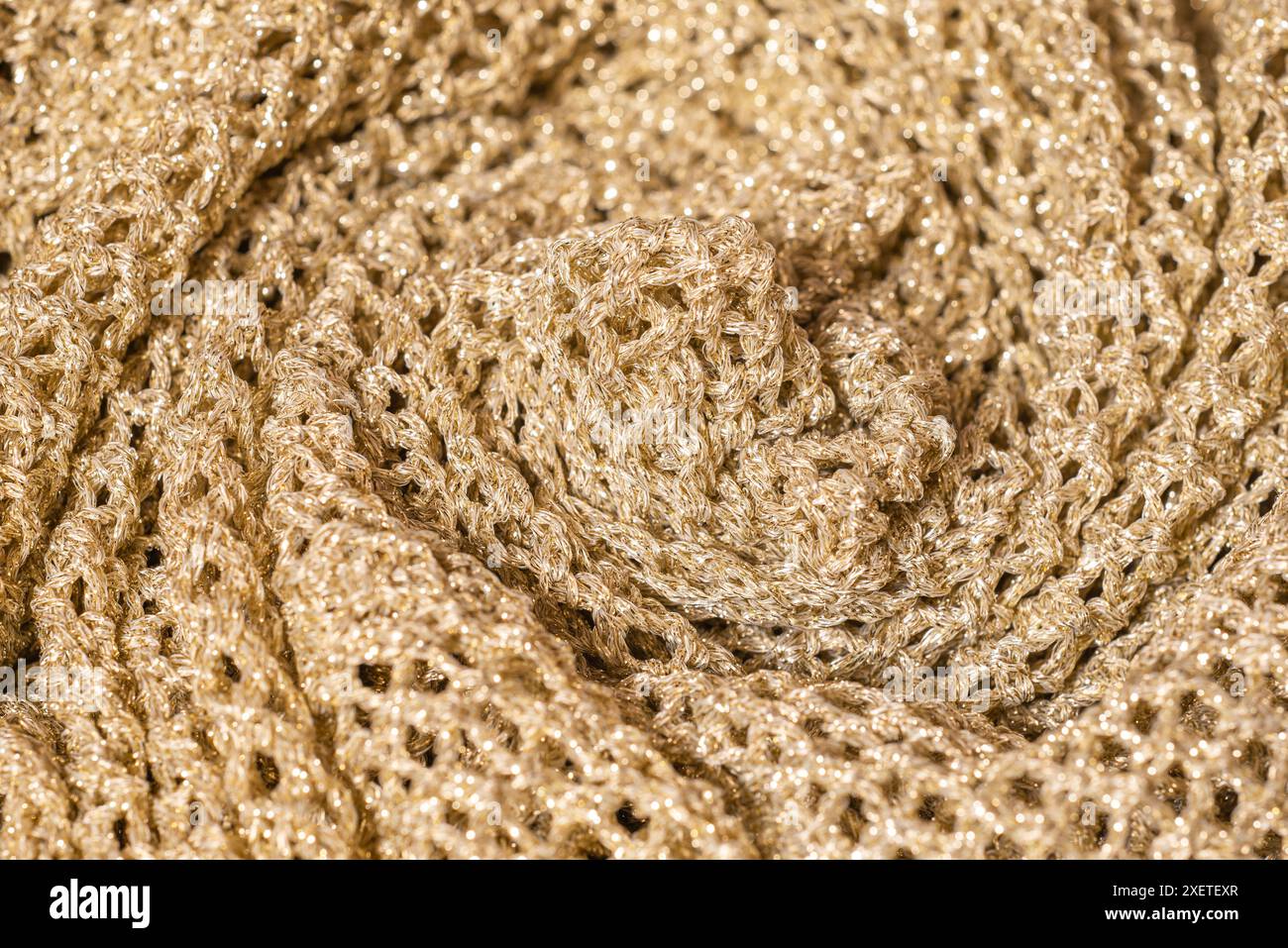 Twisted pleated knit fabric with golden thread Stock Photo - Alamy