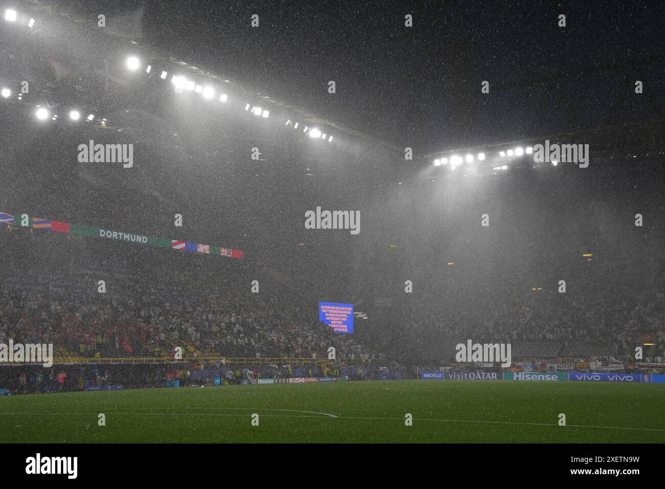 A general view of rain in the stadium during a break of play due to ...