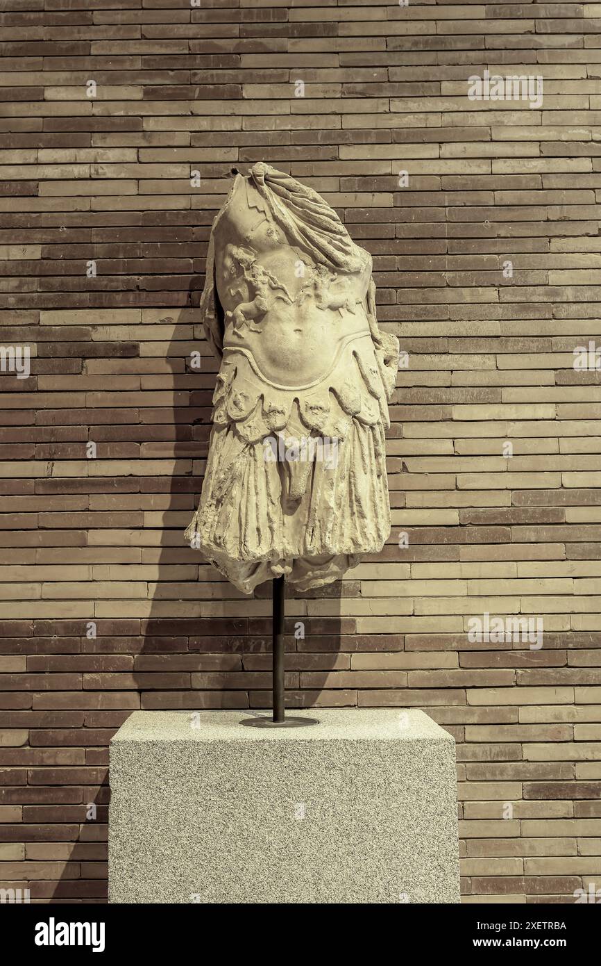 A marble statue of a Roman emperor in military dress, highlighting ...