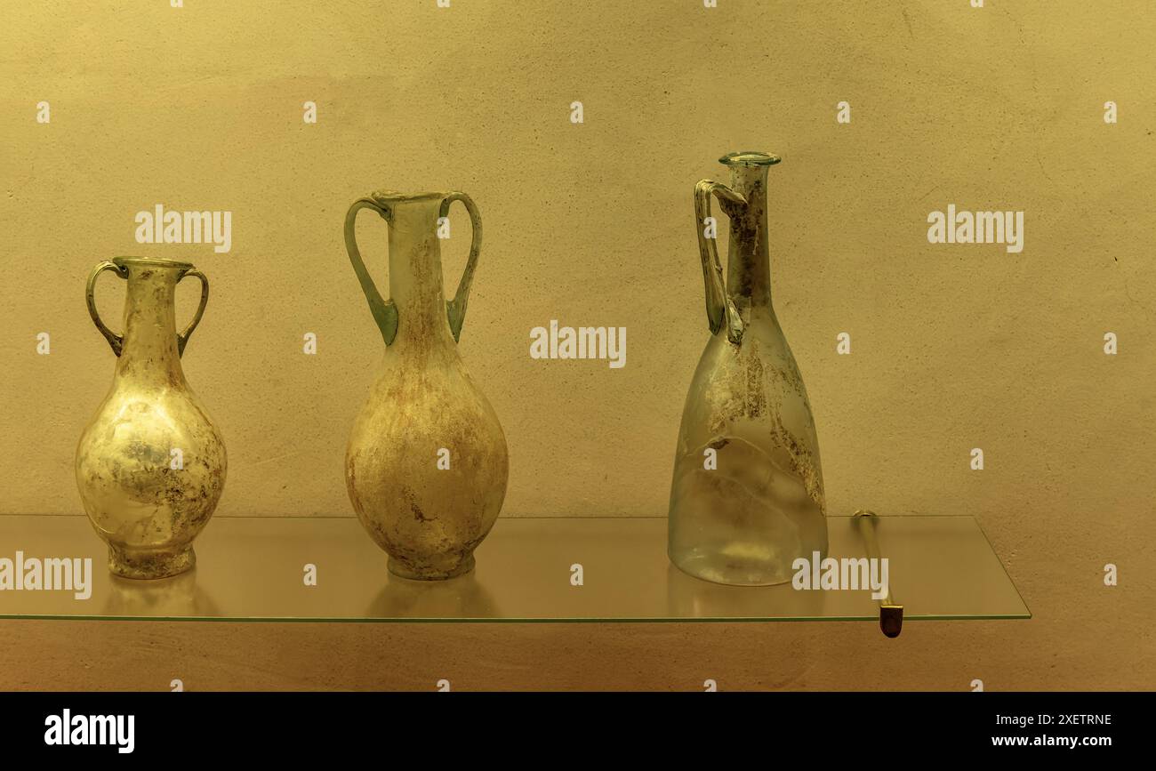 An ancient Roman green glass vase with intricate design. Features a ...