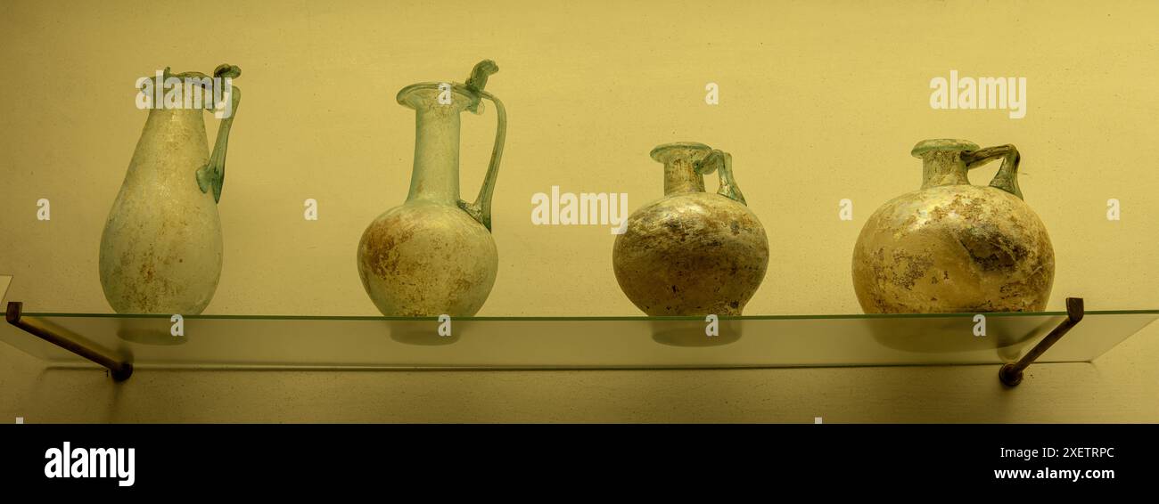 An ancient Roman green glass vase with intricate design. Features a ...