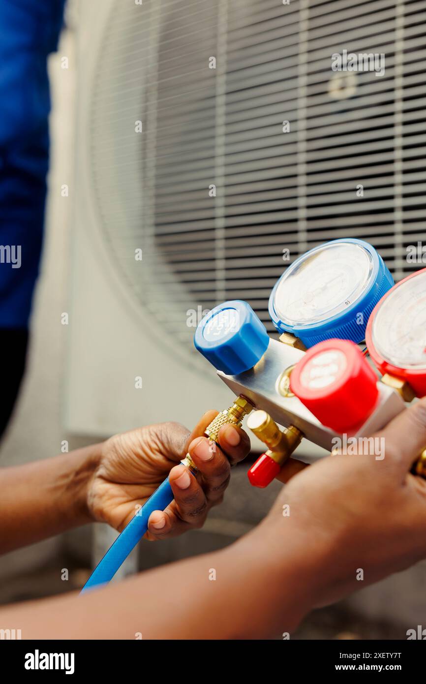 Close up of competent mechanic holding manometers used for checking ...