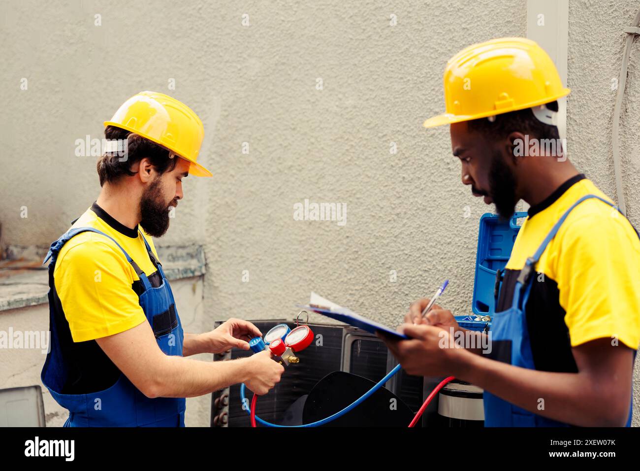 Competent mechanic using manifold gauges to read pressure of liquids ...