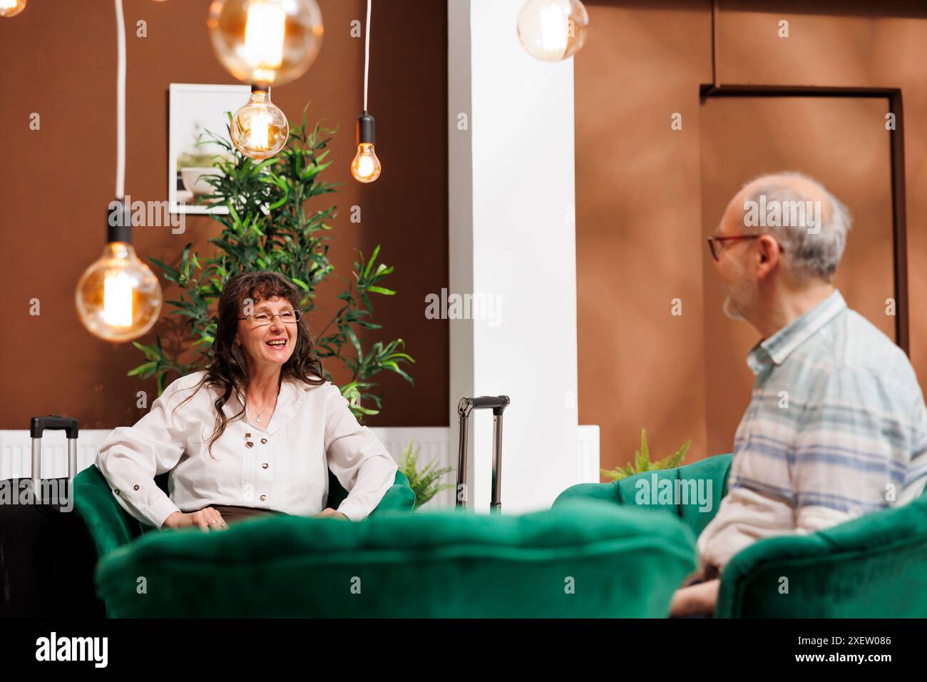 Guests interacting reception staff hotel hi-res stock photography and ...