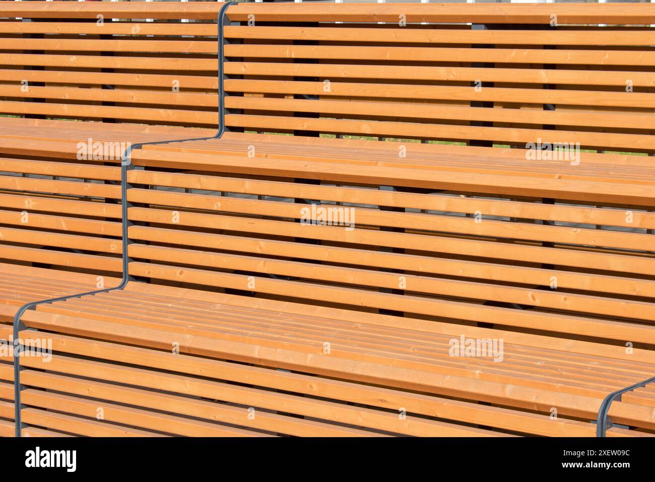 wooden sports stands , benches in the outdoor park closeup. sunny ...