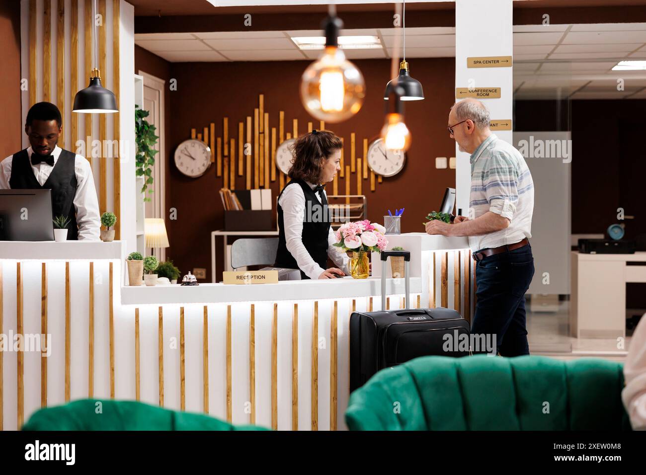 Guest arriving checking in man luggage hi-res stock photography and ...