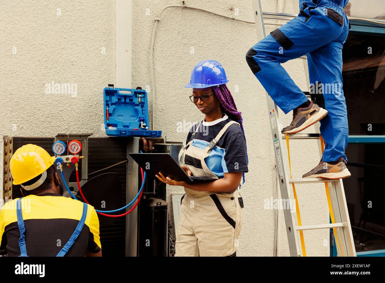 Skilled african american engineer cleaning and lubricating air ...