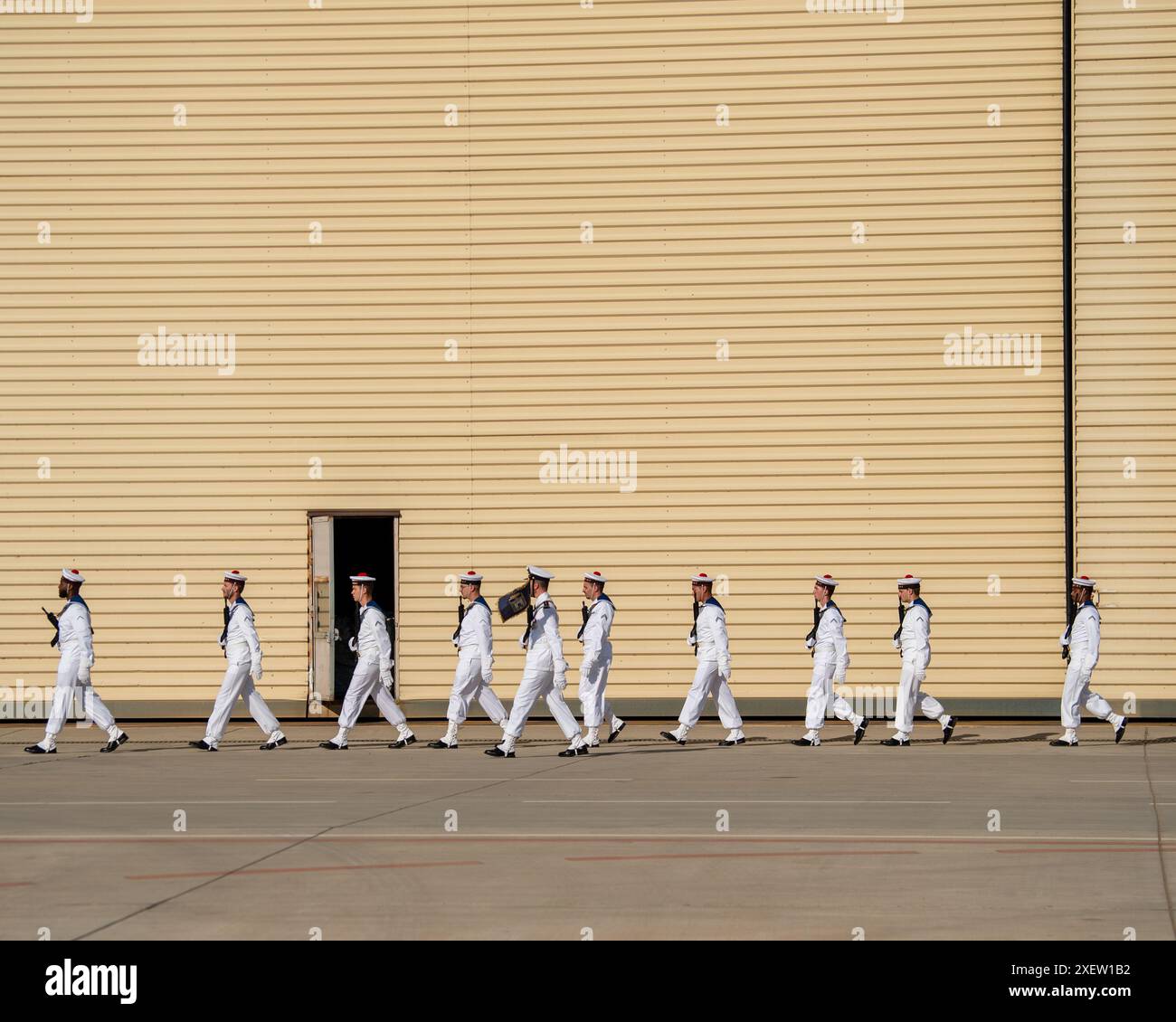 Members of naval base walk after the ceremony to hand over the emergency alert from a Dauphin SP ...