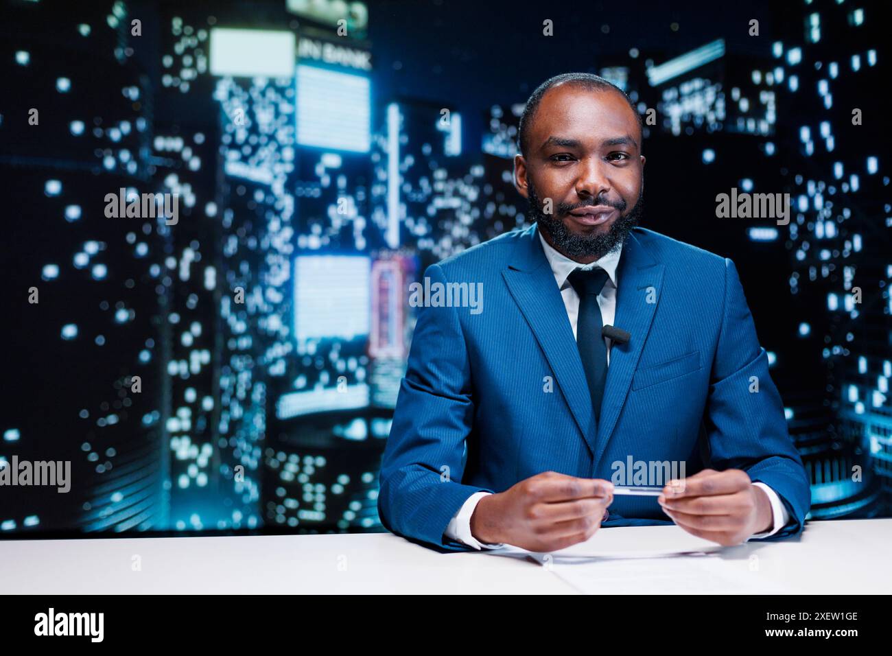 News presenter on live night show transmitting latest information ...