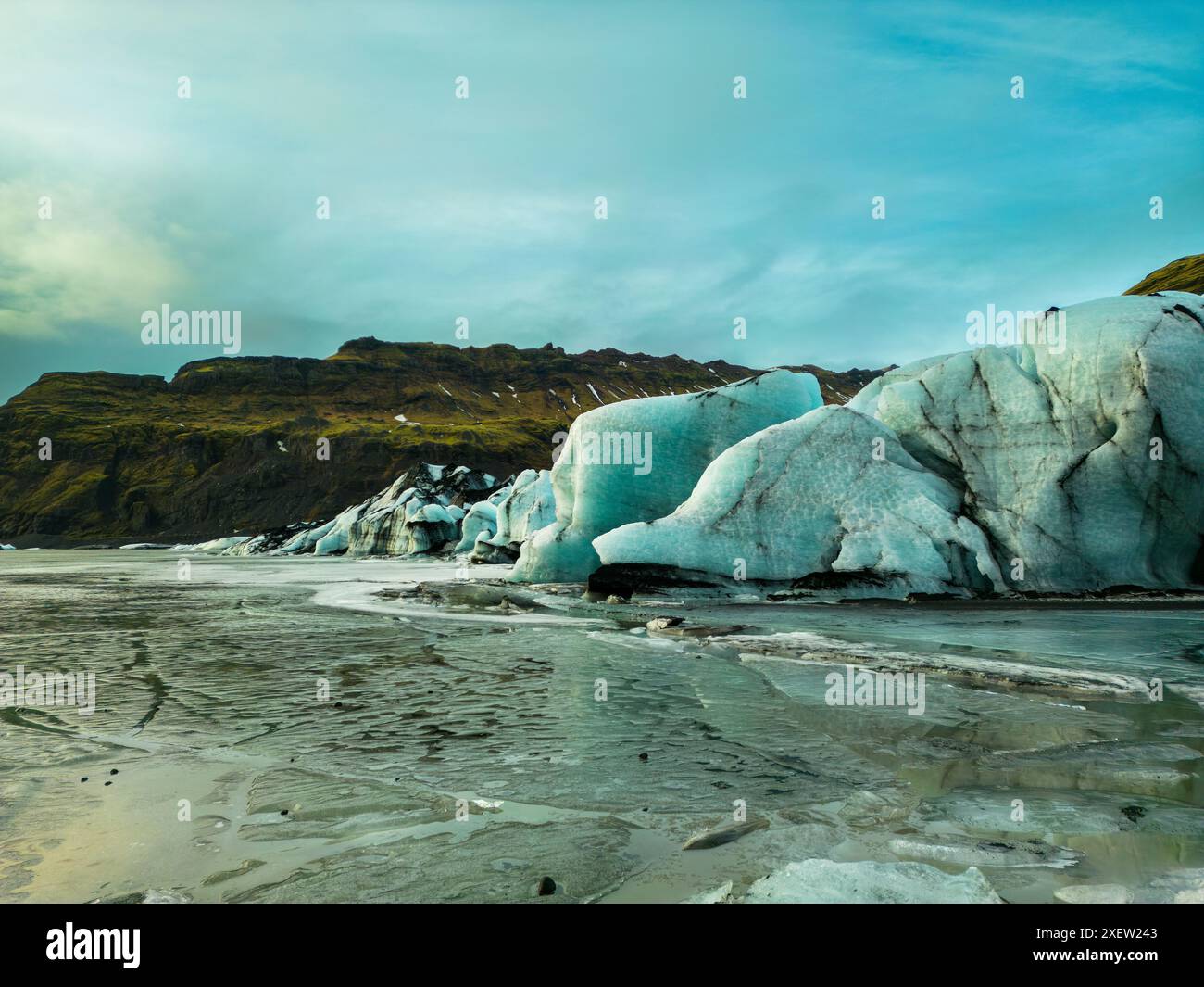 Drone shot of lake with ice cap, vatnajokull glacier mass forming ...