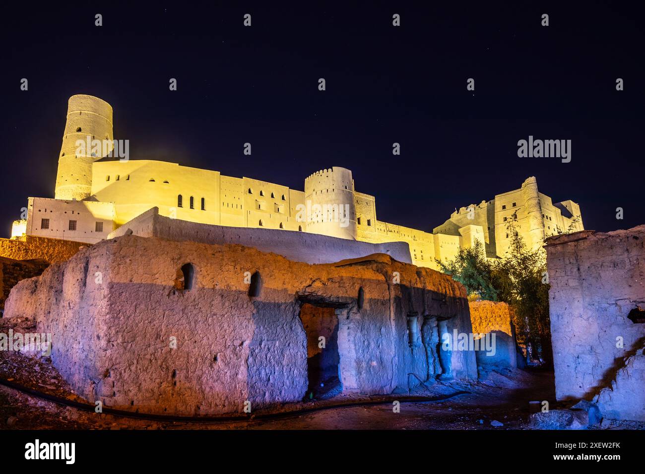 Bahla citadel fortress stone walls and round towers with old building ...