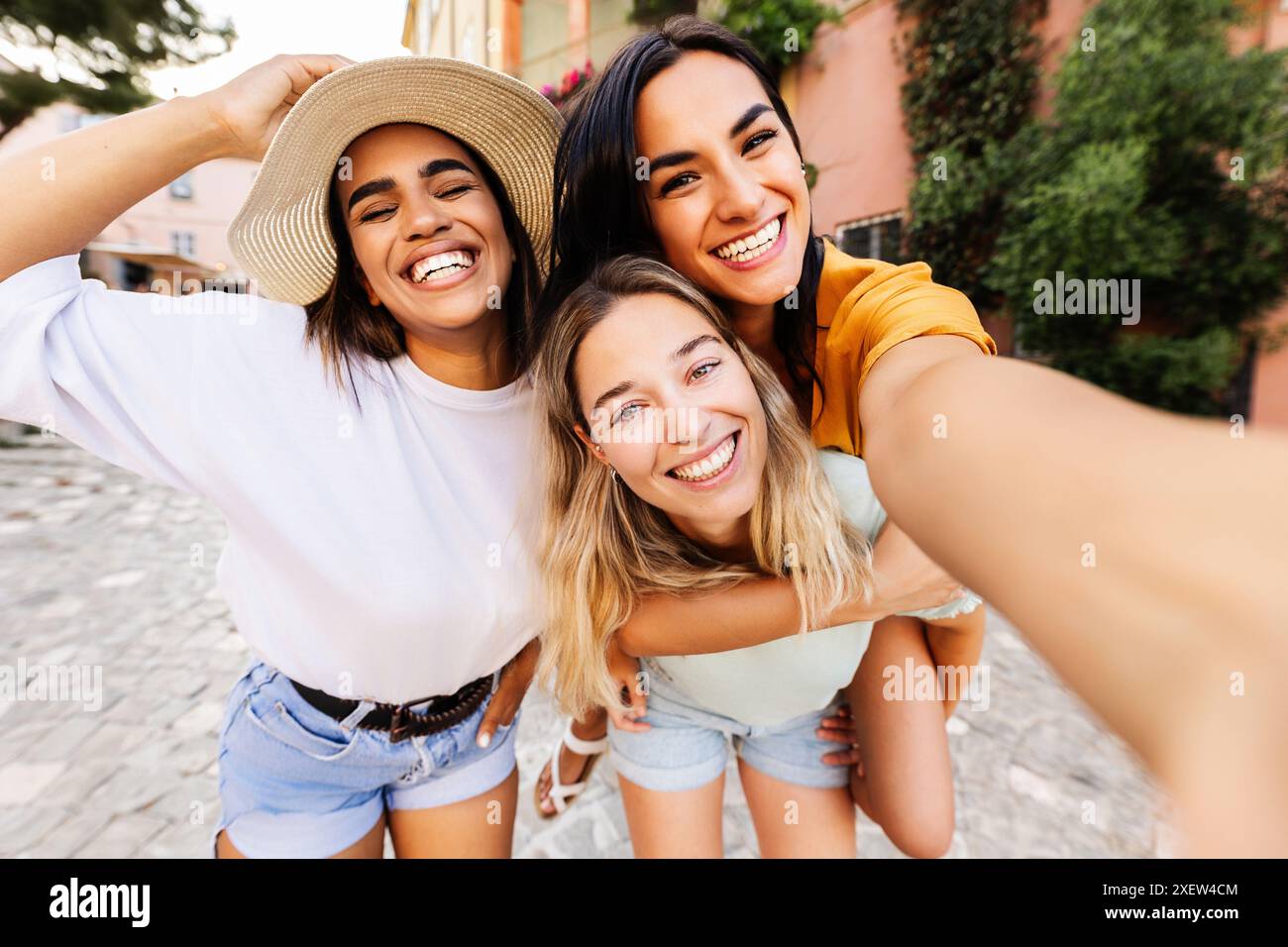 Diverse group of three happy young women having fun on summer vacation ...