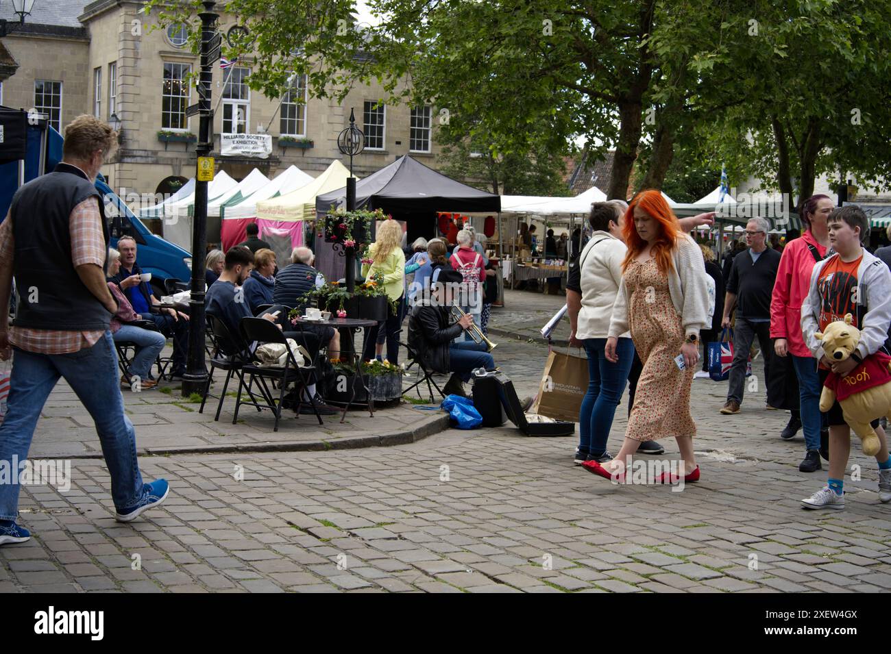 Busy market day with a musician performing in Wells, Somerset Stock ...