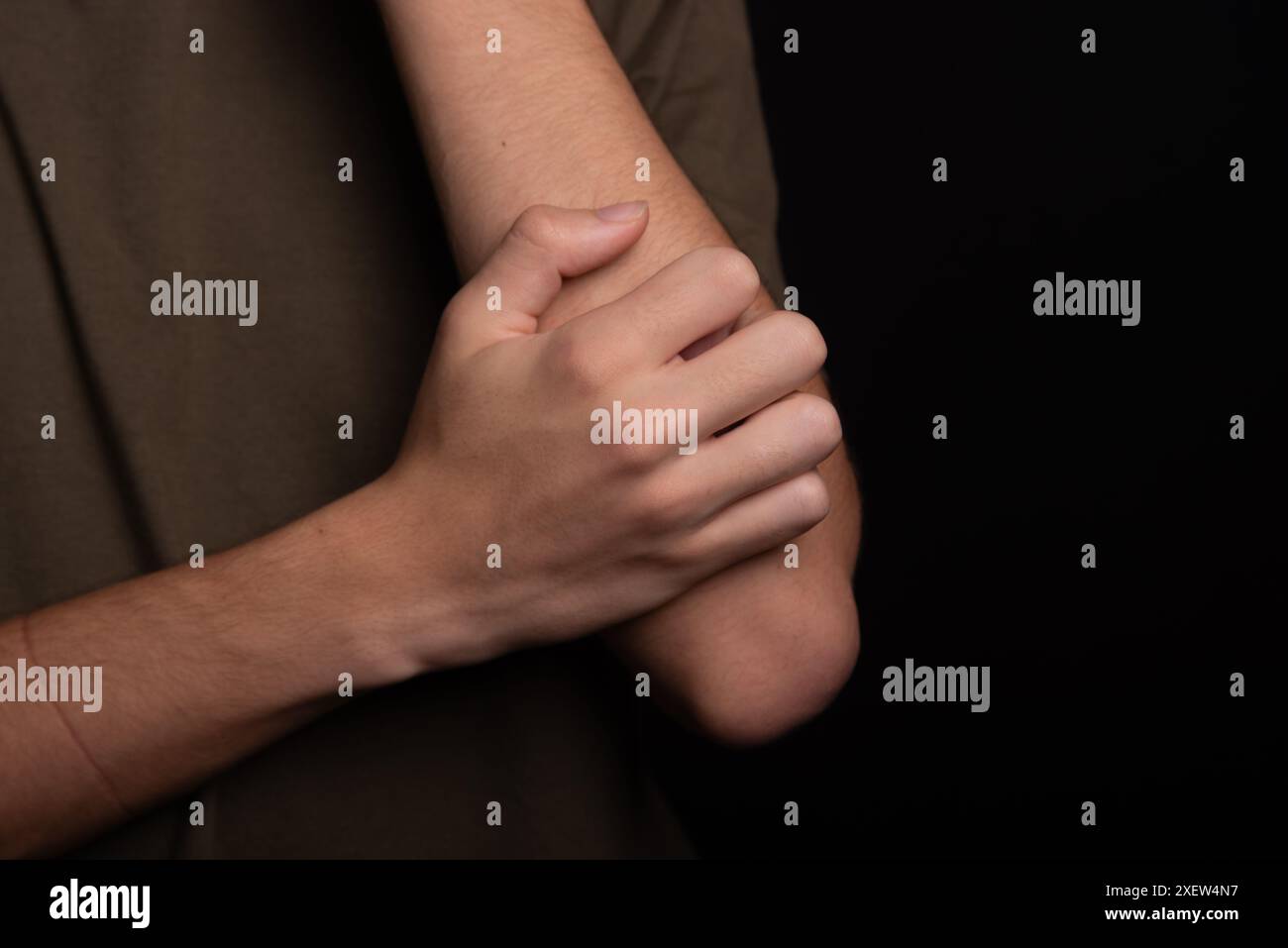 Young man scratching his arm with his hand. Skin disease. Irritation ...