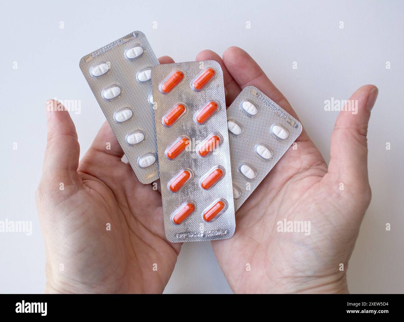 Human hands holding medical capsules packed in blisters. Healthcare ...