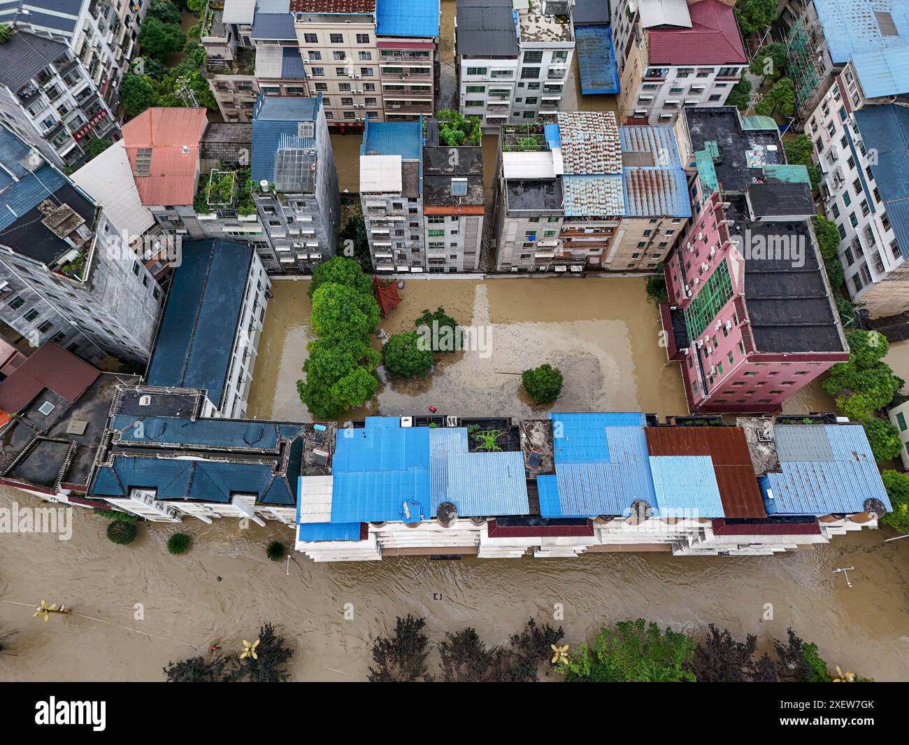 QIANDONGNAN, CHINA - JUNE 29, 2024 - Aerial photo of houses and fields ...
