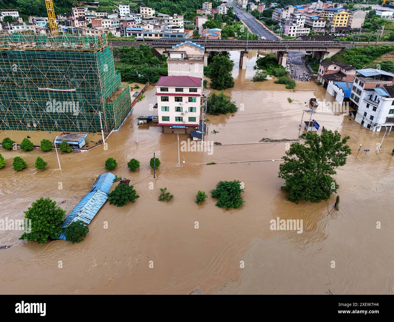 QIANDONGNAN, CHINA - JUNE 29, 2024 - Aerial photo of houses and fields ...