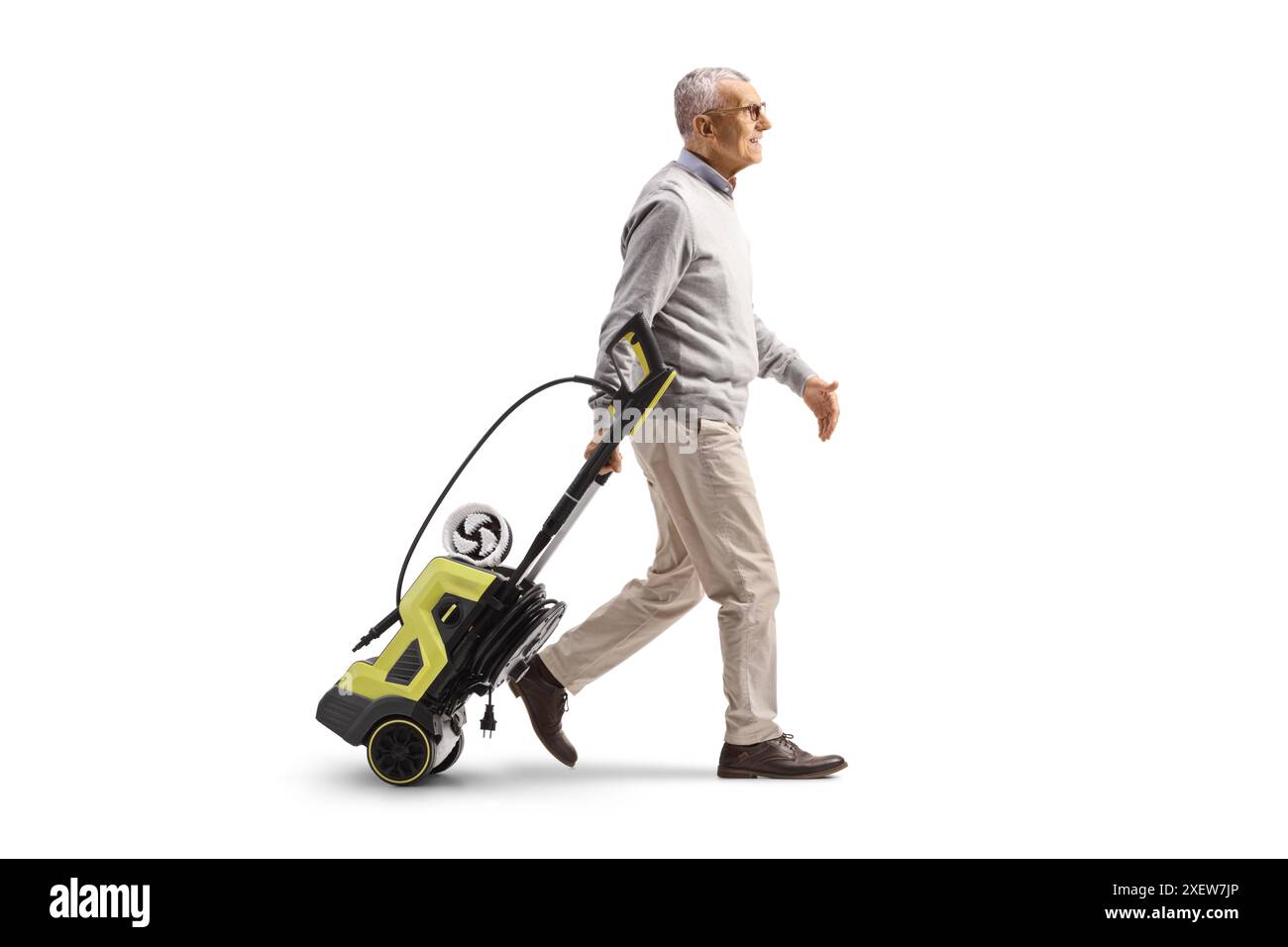 Elderly man walking and pulling a high pressure washer machine isolated ...