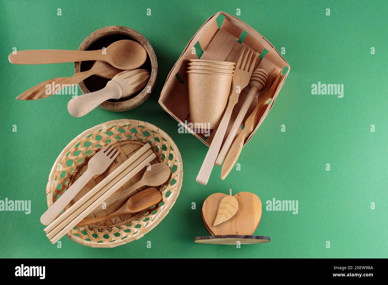 Reusable Wooden Cutlery and Cardboard Disposable Cups on Green ...