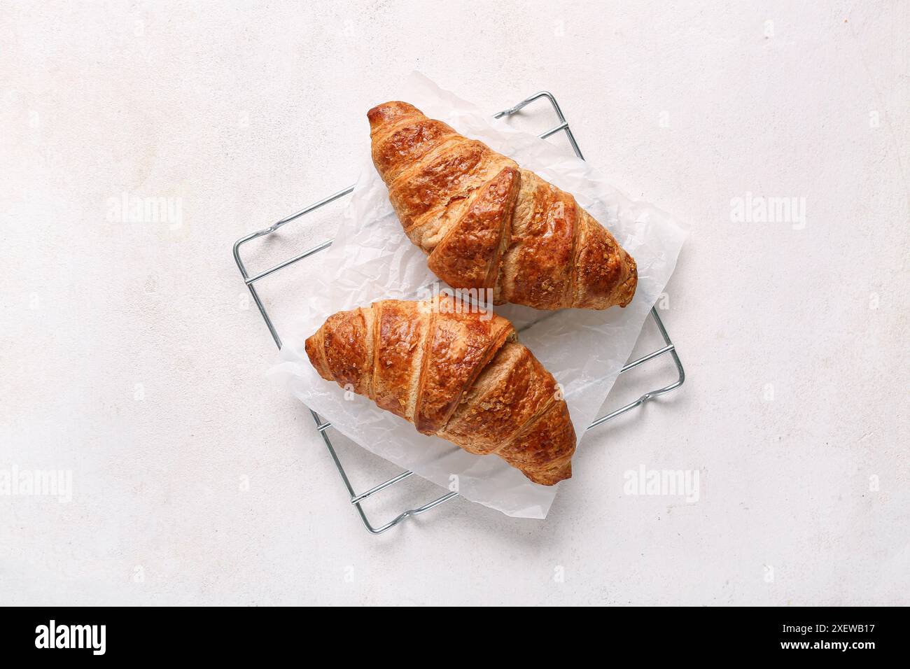 Stand with tasty croissants on white background Stock Photo - Alamy