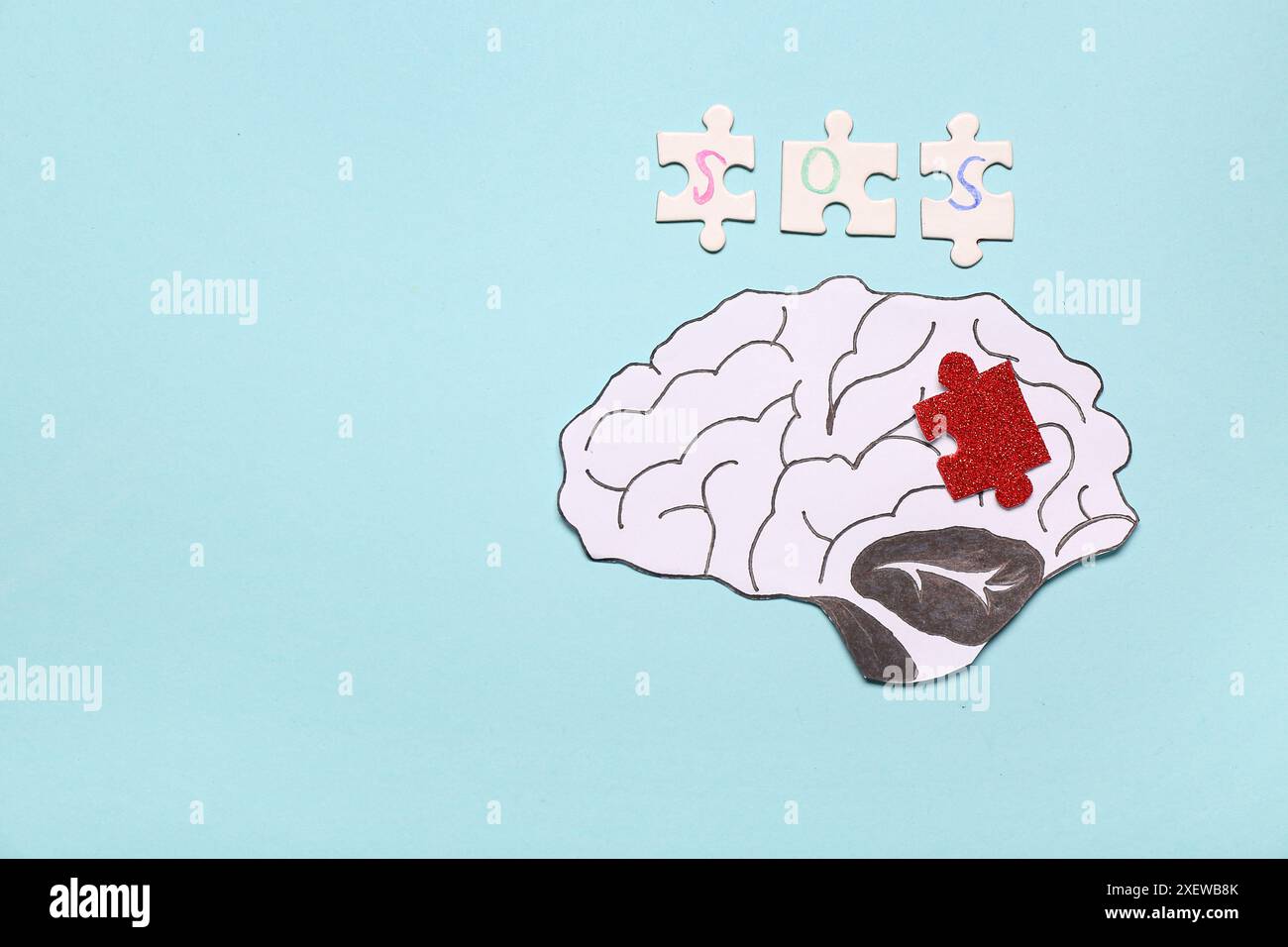 Paper brain with, puzzle pieces and word SOS on blue background ...