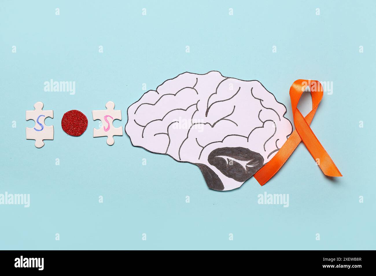 Paper brain, orange ribbon, puzzle pieces and word SOS on blue ...