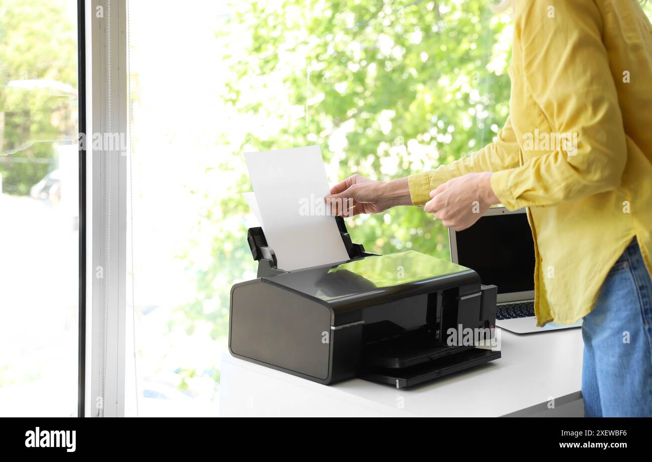 Mature woman using printer at home, closeup Stock Photo - Alamy