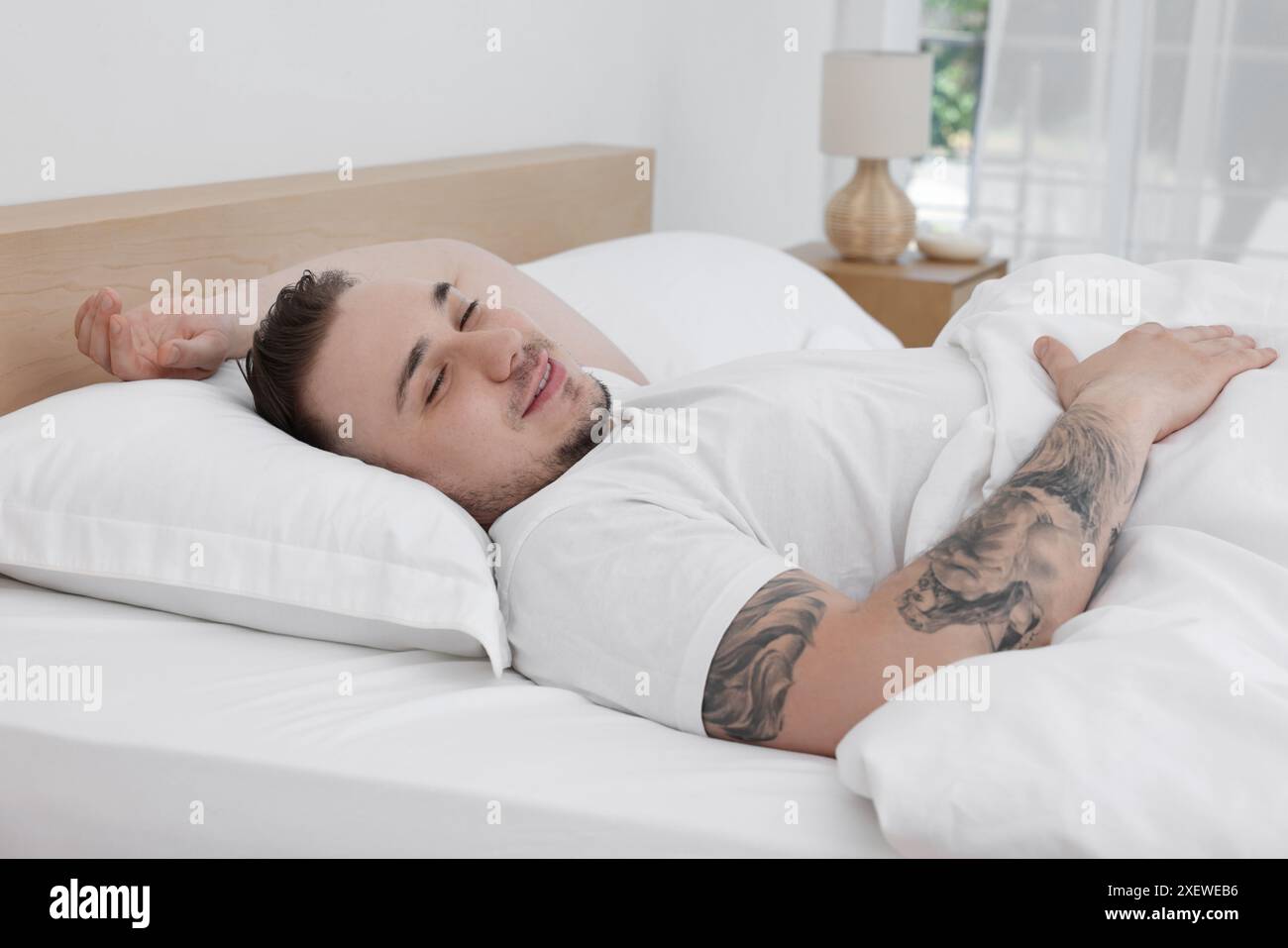 Bedtime. Handsome man sleeping in bed indoors Stock Photo - Alamy