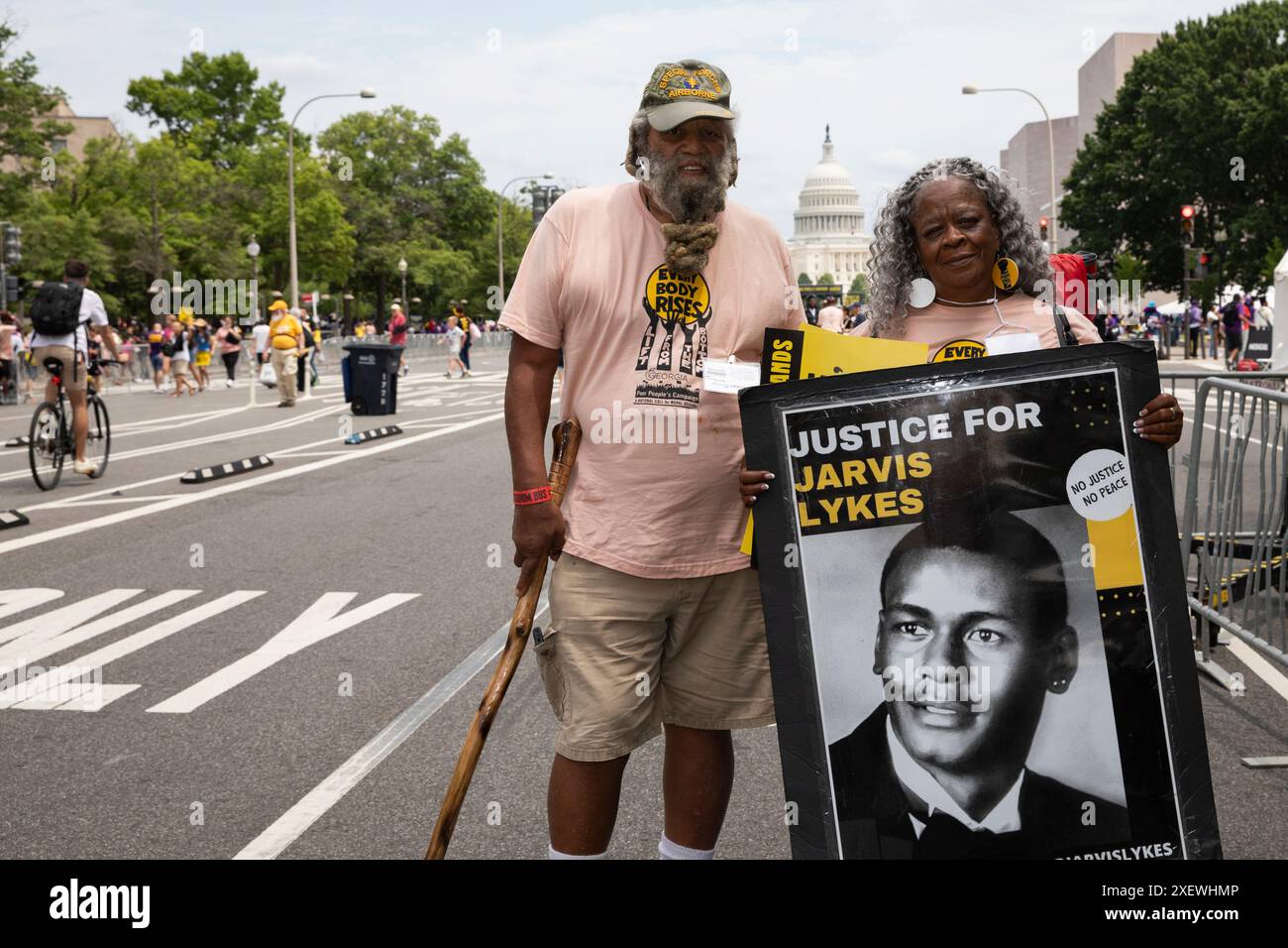 Two demonstrators are holding a sign with the words ''Justice for ...