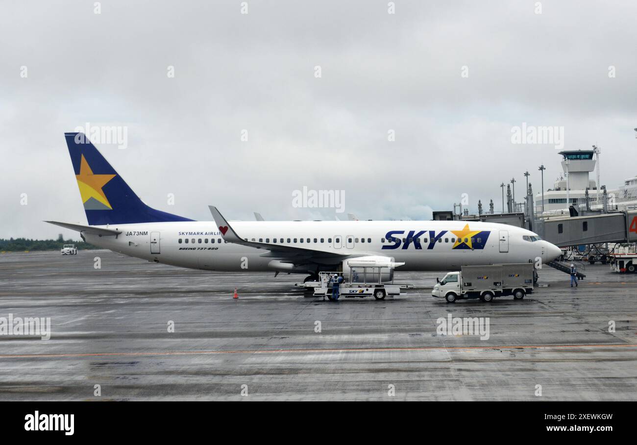 A Skymark airlines plane taxing by the gate at Kagoshima International ...