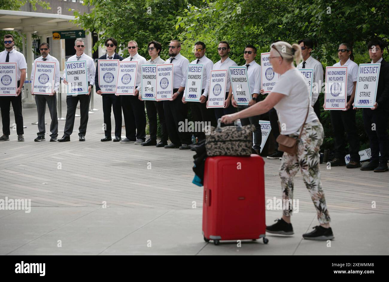 Vancouver, Canada. 29th June, 2024. A passenger walks past WestJet ...