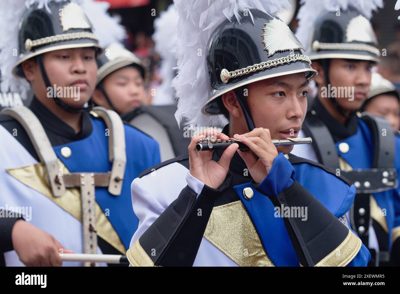Thai school boys in a marching band in Phuket Town, Thailand, playing during a tourism promotion ...