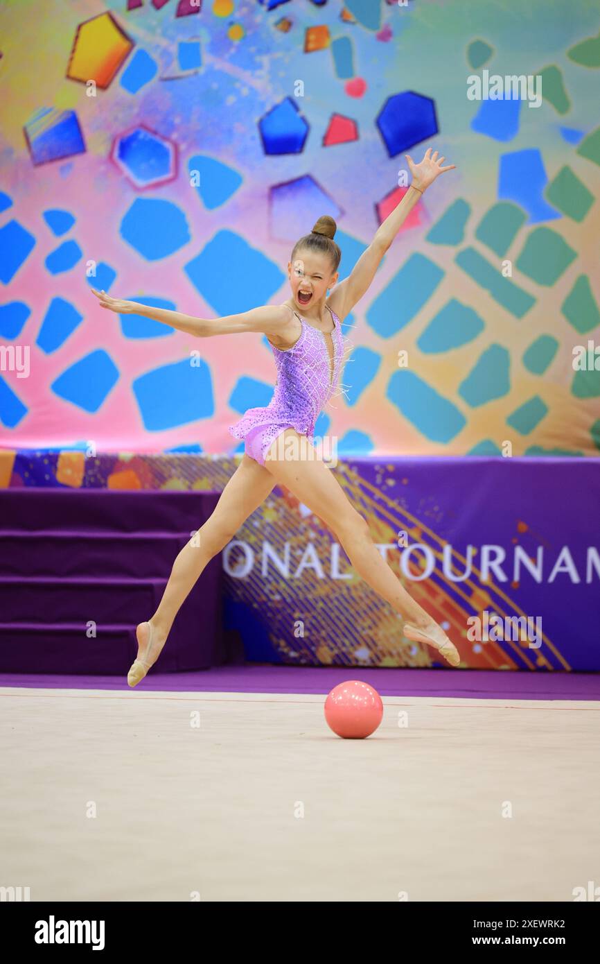 Watch the rhythmic gymnast perform a stunning jump with a ribbon at a ...