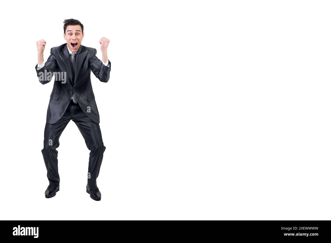 Excited man celebrating victory in studio. White background Stock Photo ...