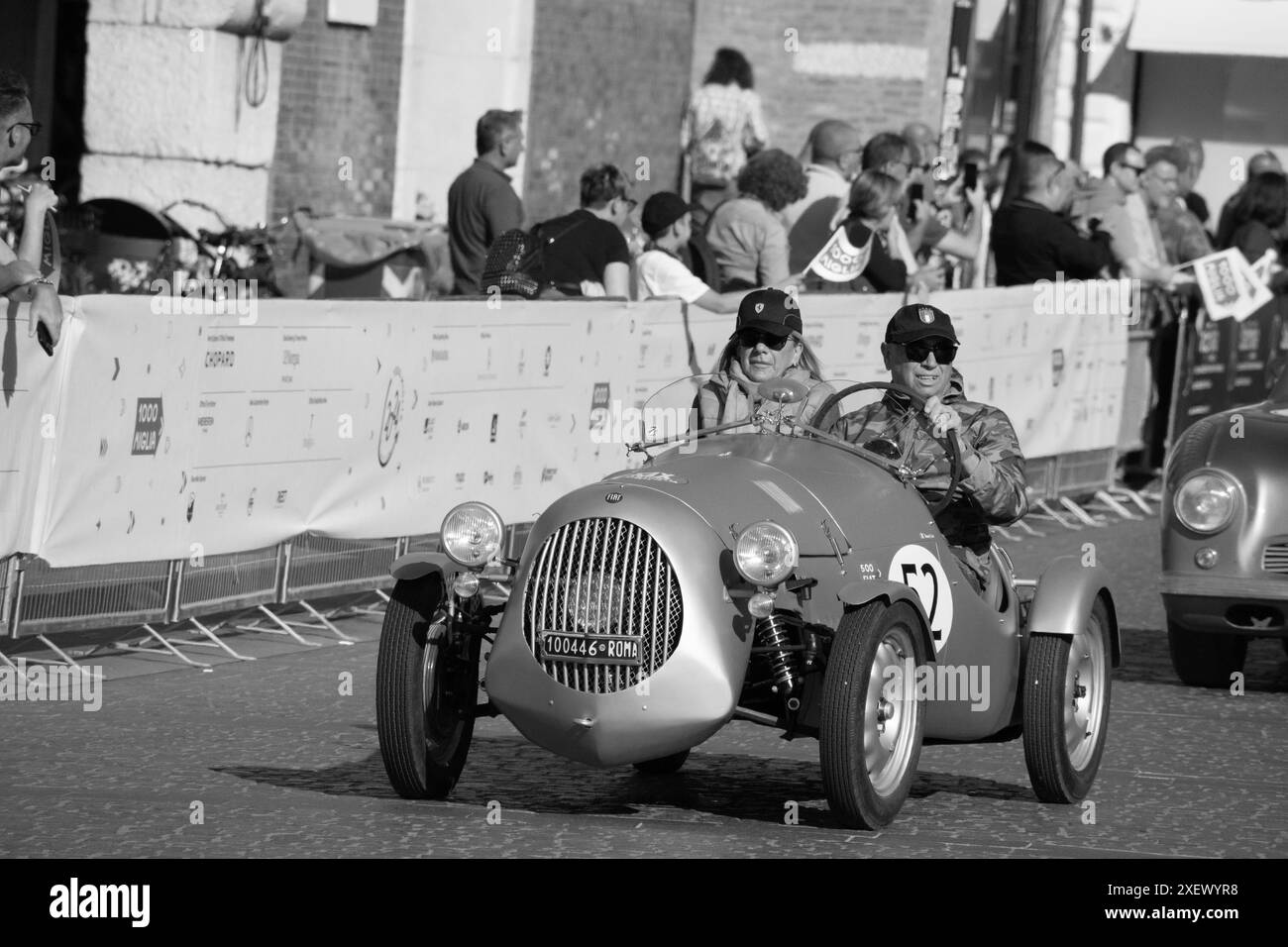 FERRARA , ITALY - jun 15 -2024 : A classic car races through the ...