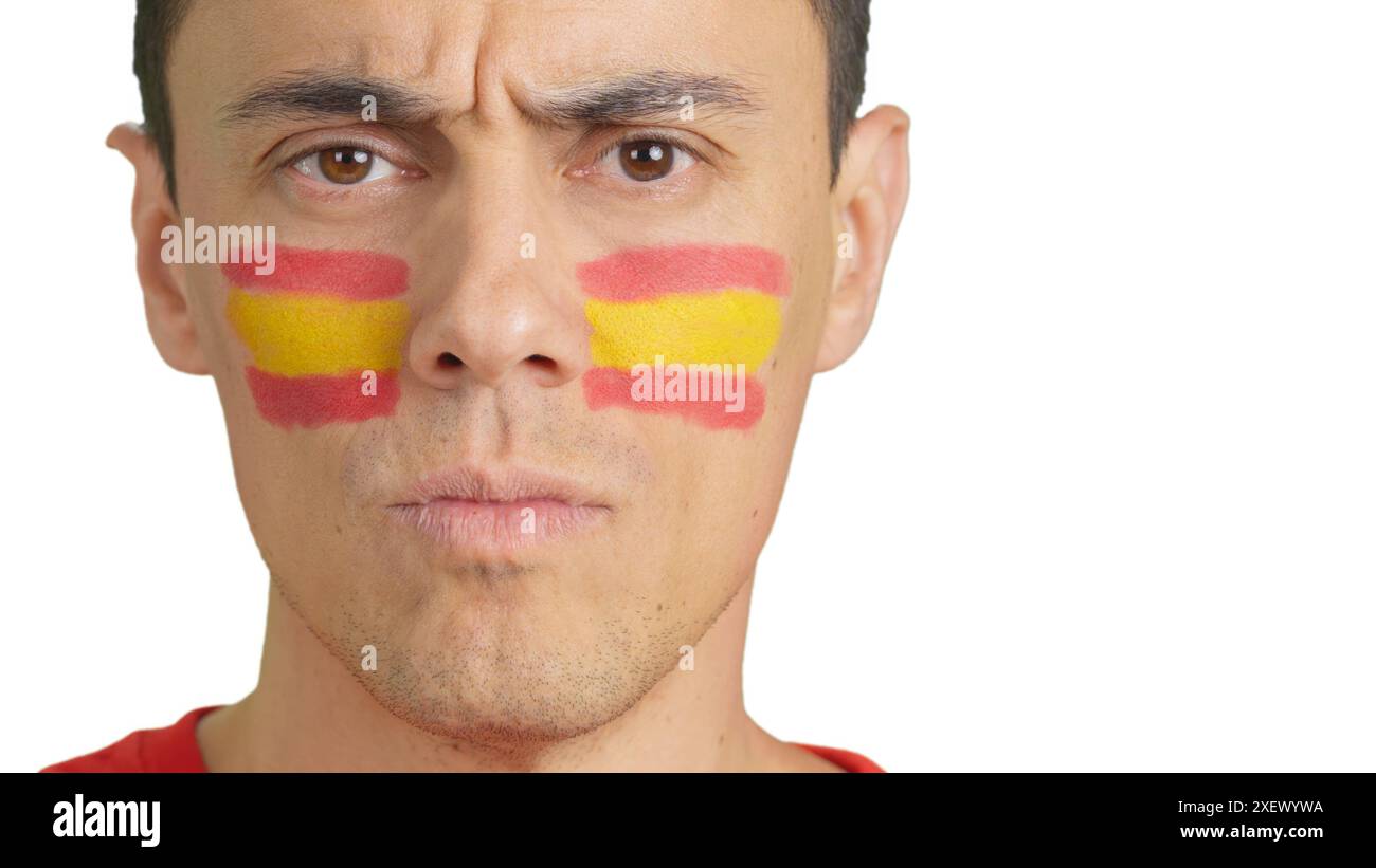 Serious man with a spanish flag painted on the face Stock Photo - Alamy