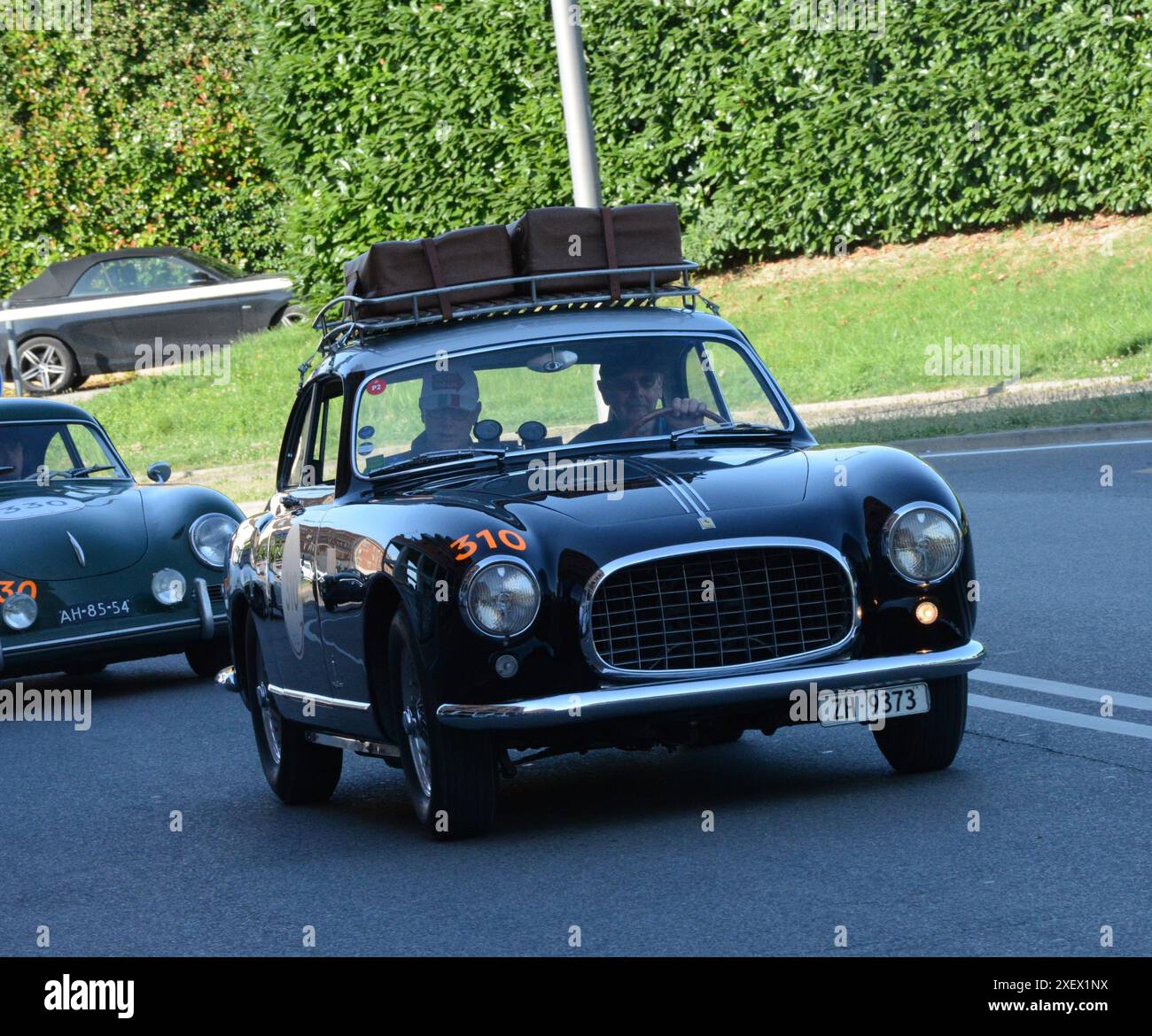 FERRARA , ITALY - jun 15 -2024 : A classic car races through the ...