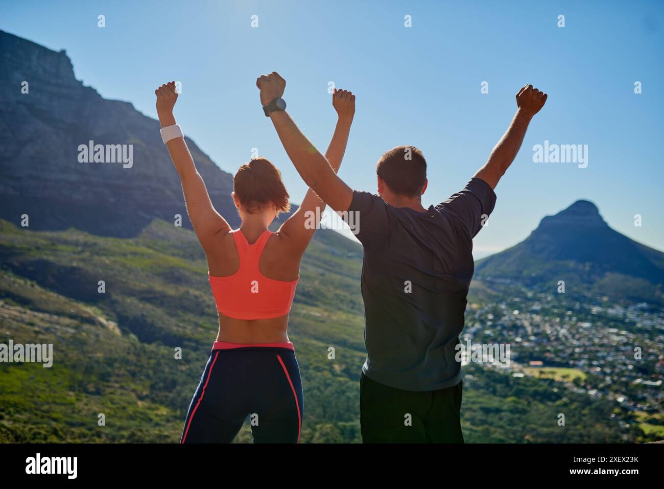 Happy couple, back and fitness with fist pump on mountain for winning ...