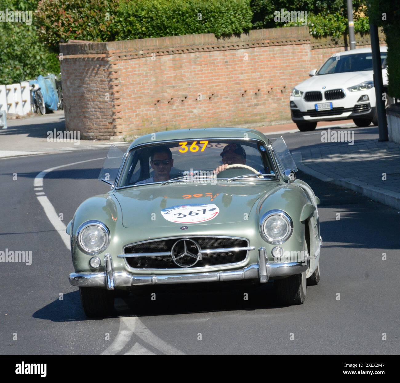 FERRARA , ITALY - jun 15 -2024 : A classic car races through the ...